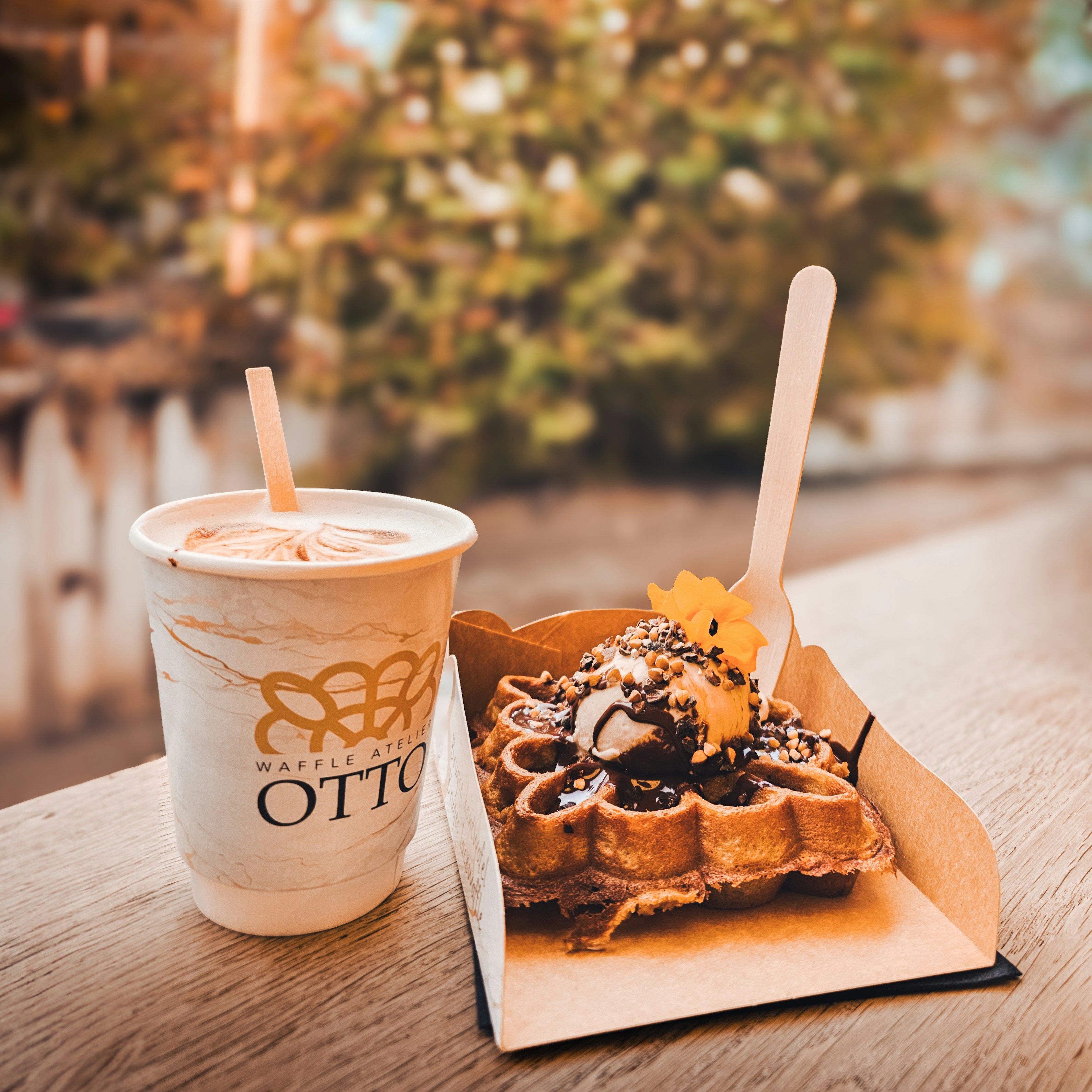 A cup of coffee and a waffle on a table