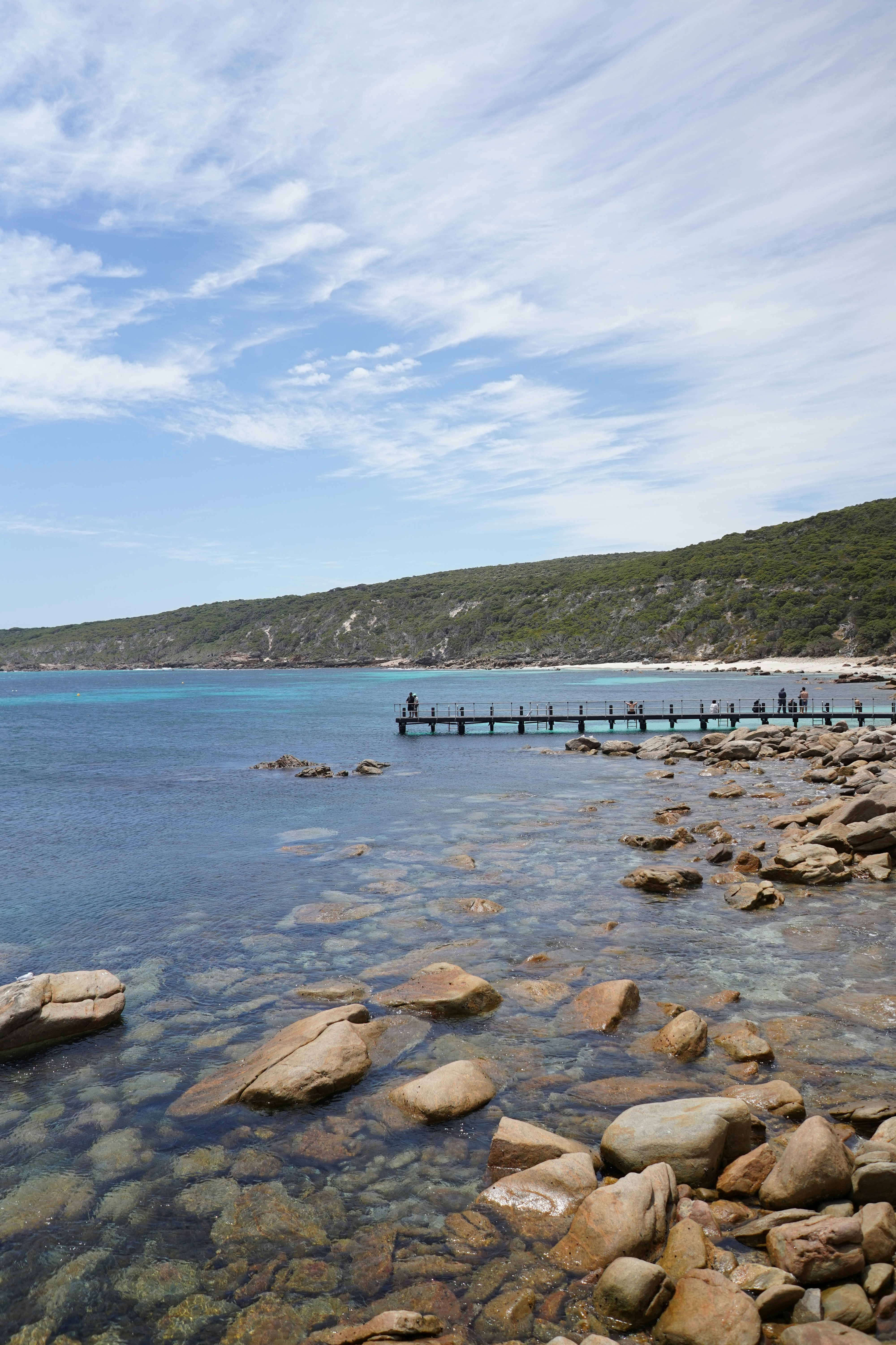 A body of water surrounded by rocks and a pier photo – Free Canal rocks ...