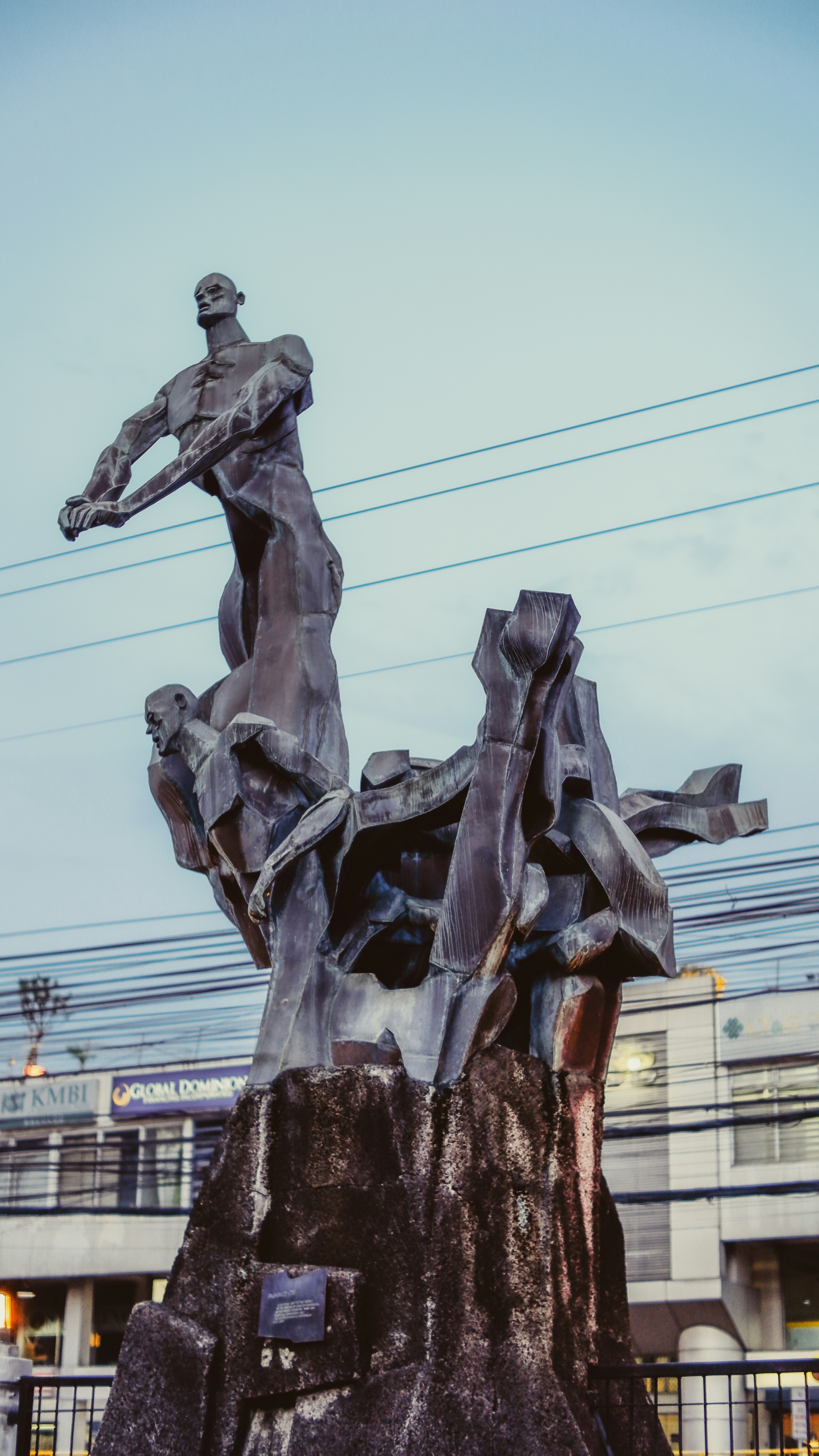 Steel Ascendant: Torqued Figures Rise Above the Urban Grid