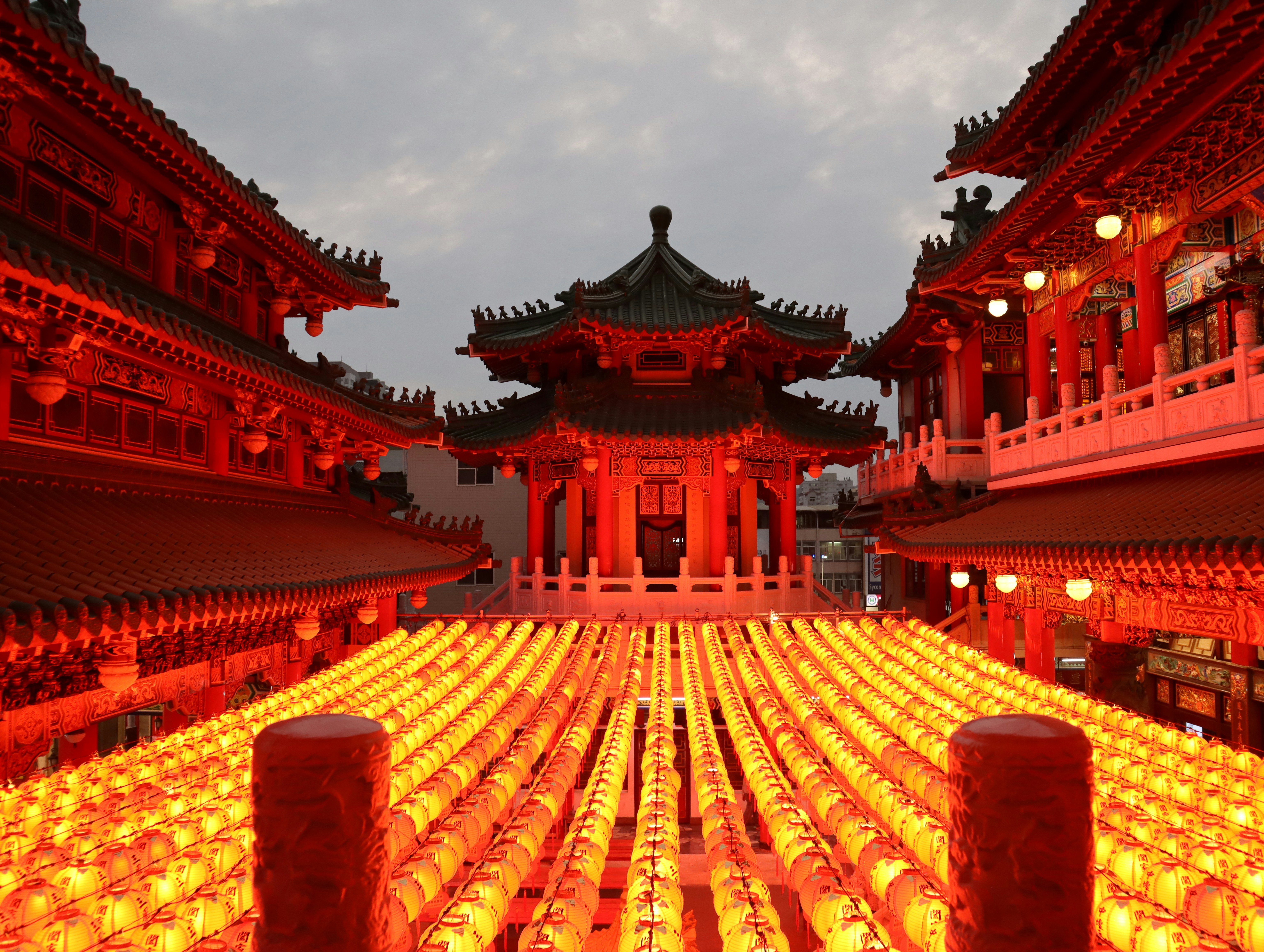 A room filled with lots of lit candles in front of a building photo ...