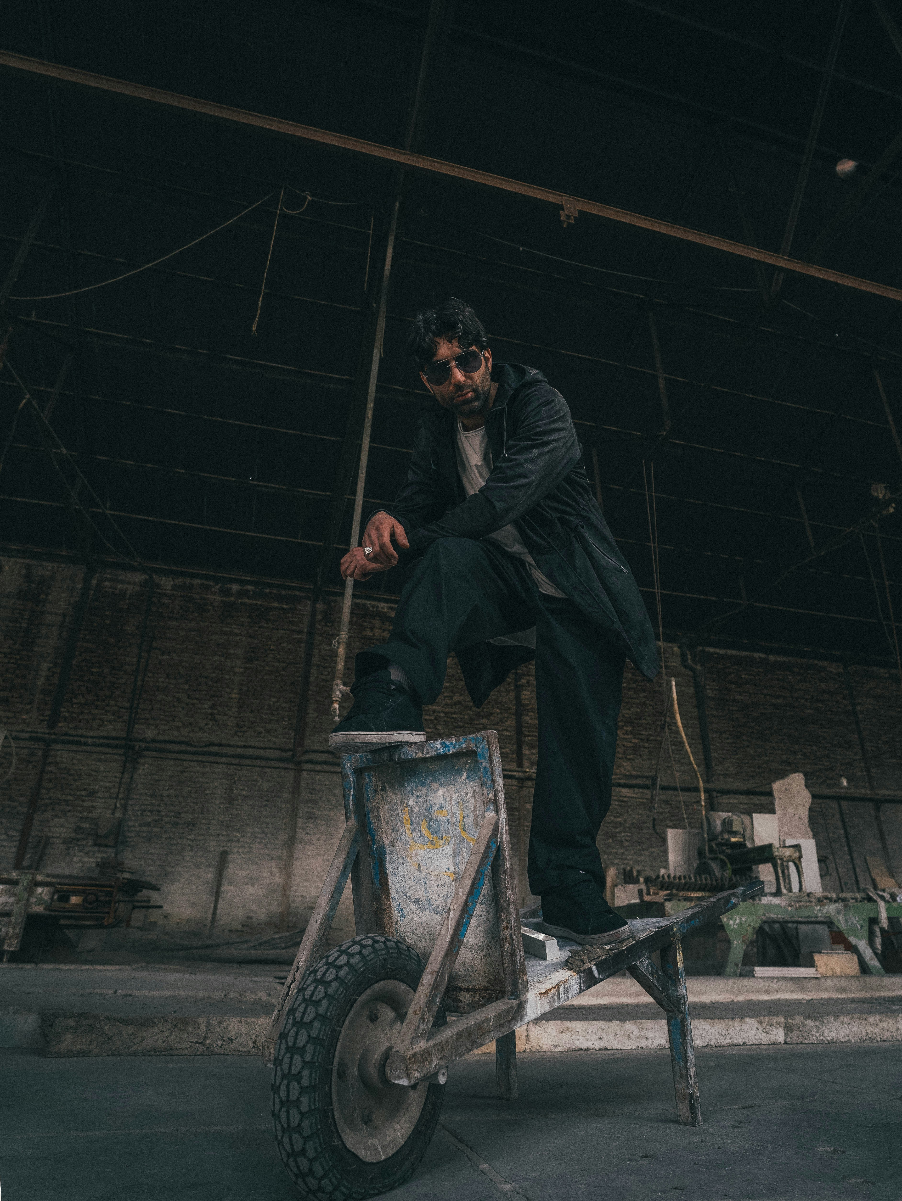 A man riding on the back of a wheelbarrow photo – Free Human Image on ...