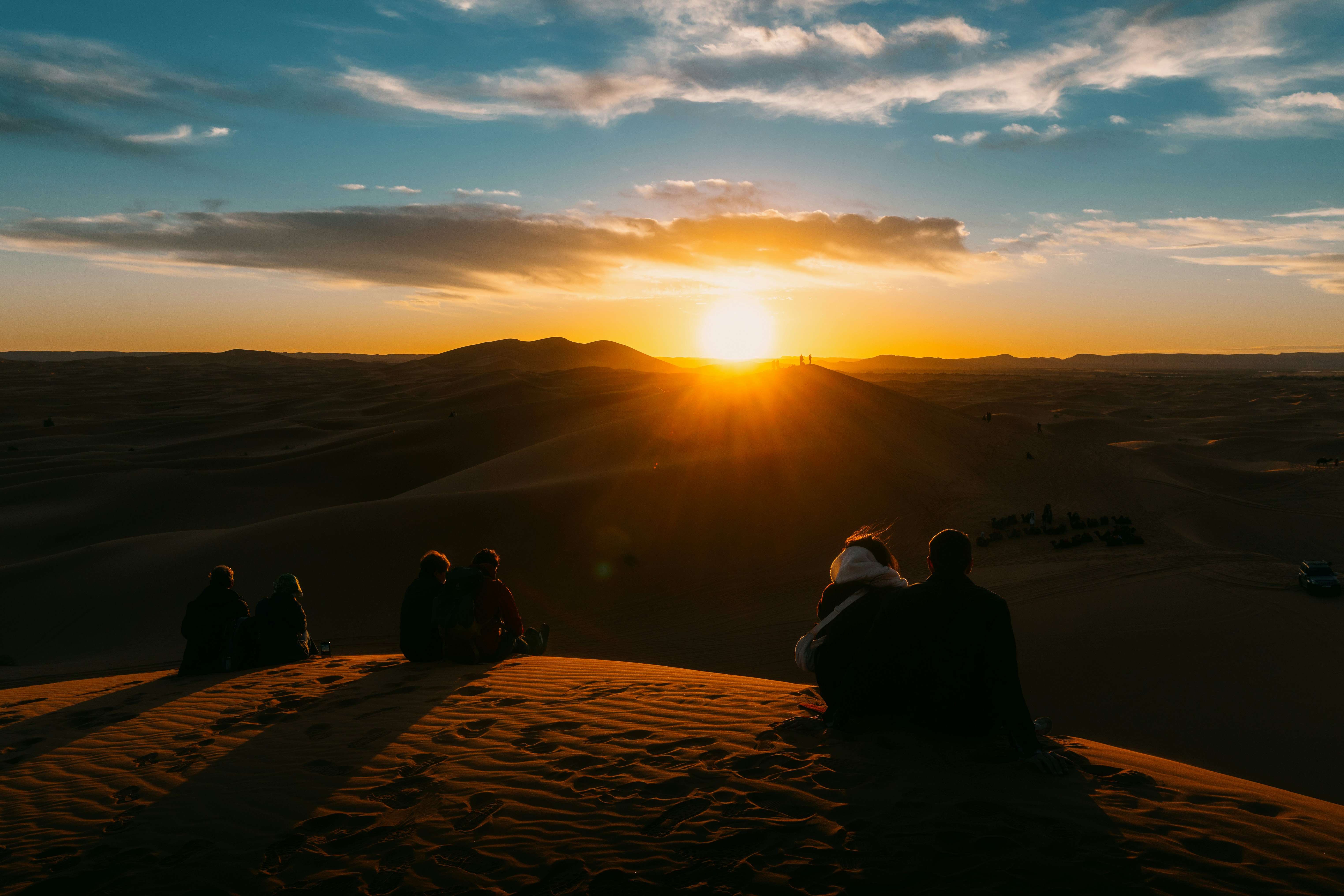 Sunset Refuge: silhouettes on the dune as the sun settles