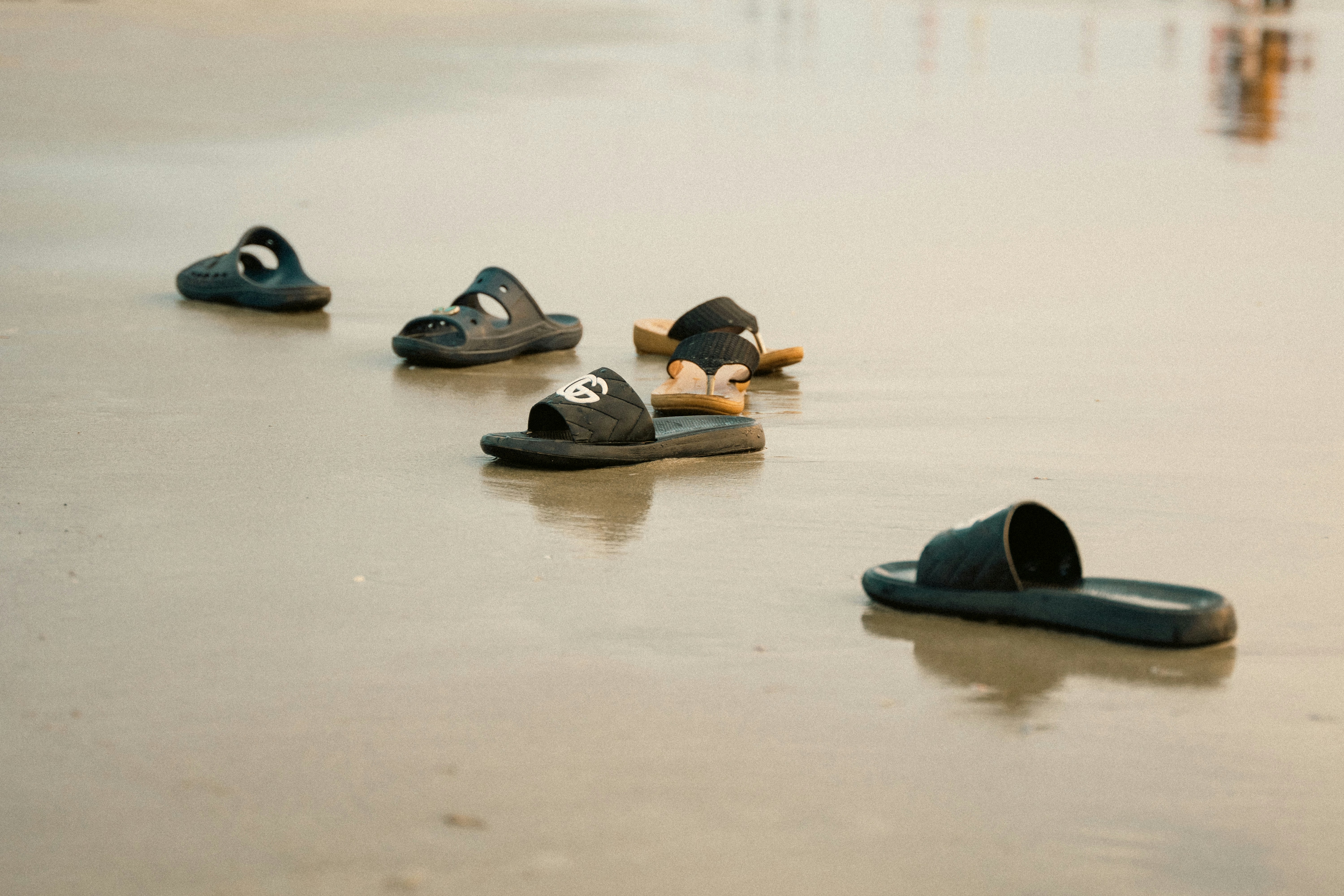 Slippers at the Tide: Quiet Color and Light on Wet Sand