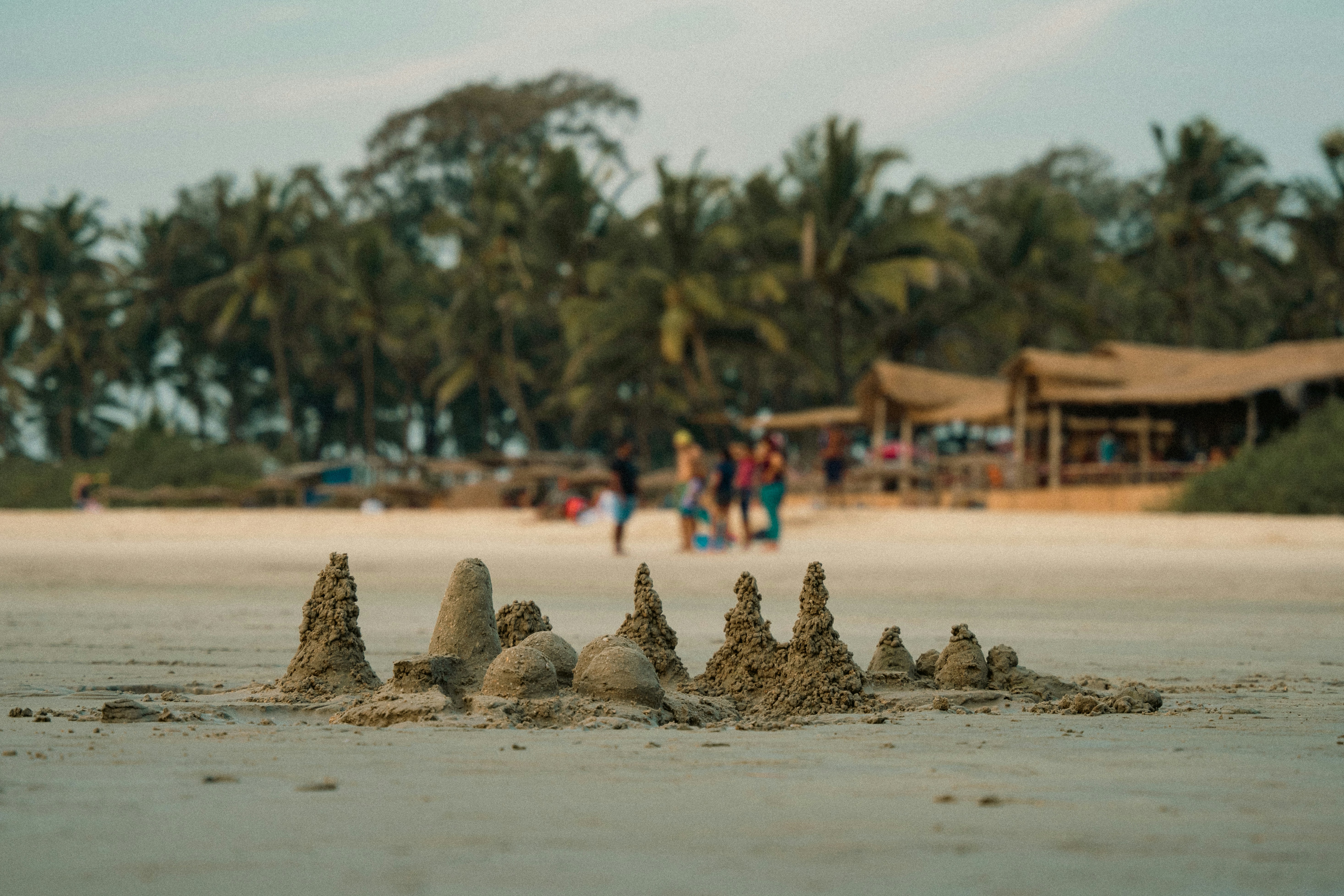 A group of sandcastles sitting on top of a sandy beach photo – Free Goa ...