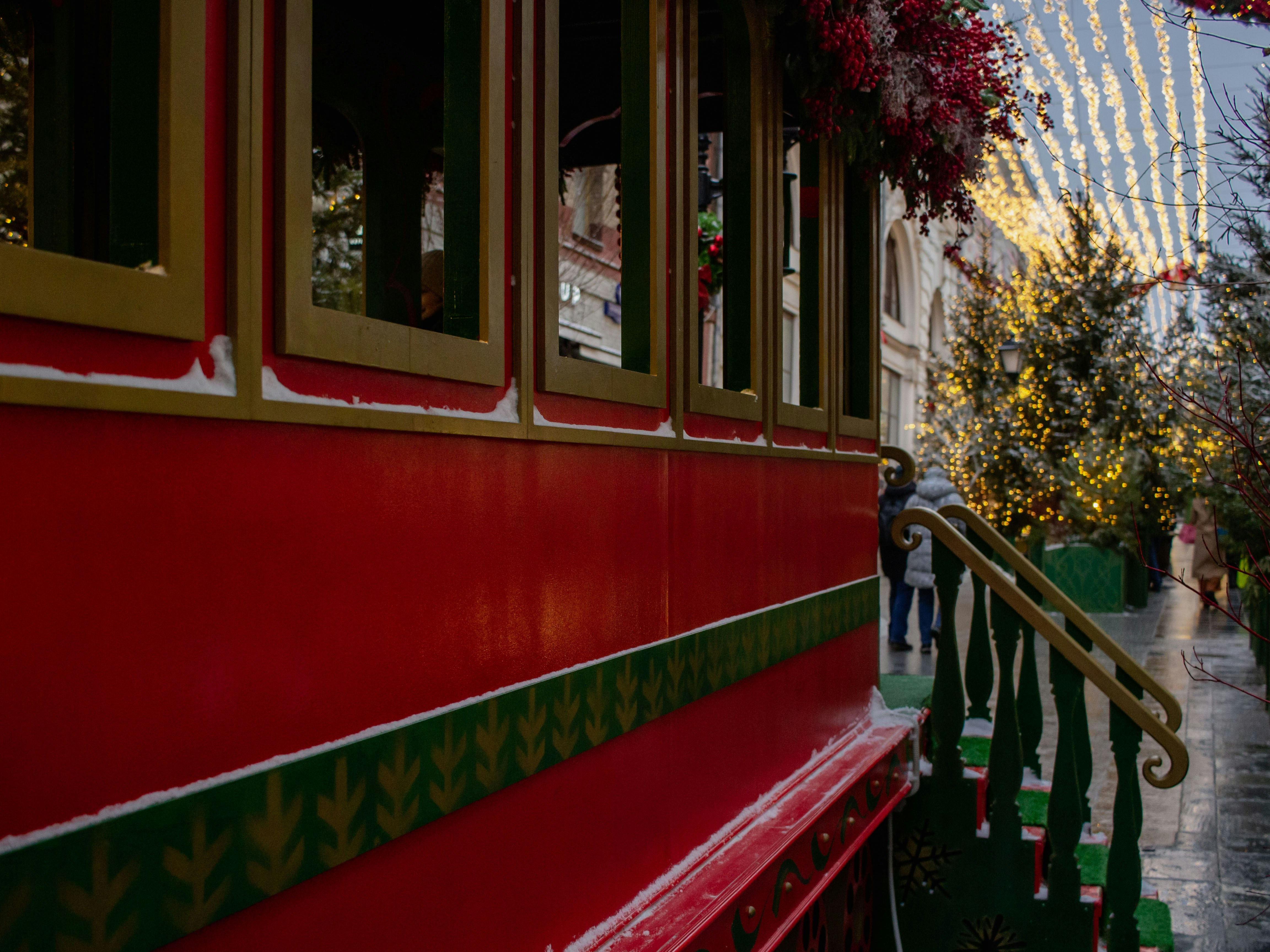 A red and green train traveling down train tracks photo – Free Russian ...