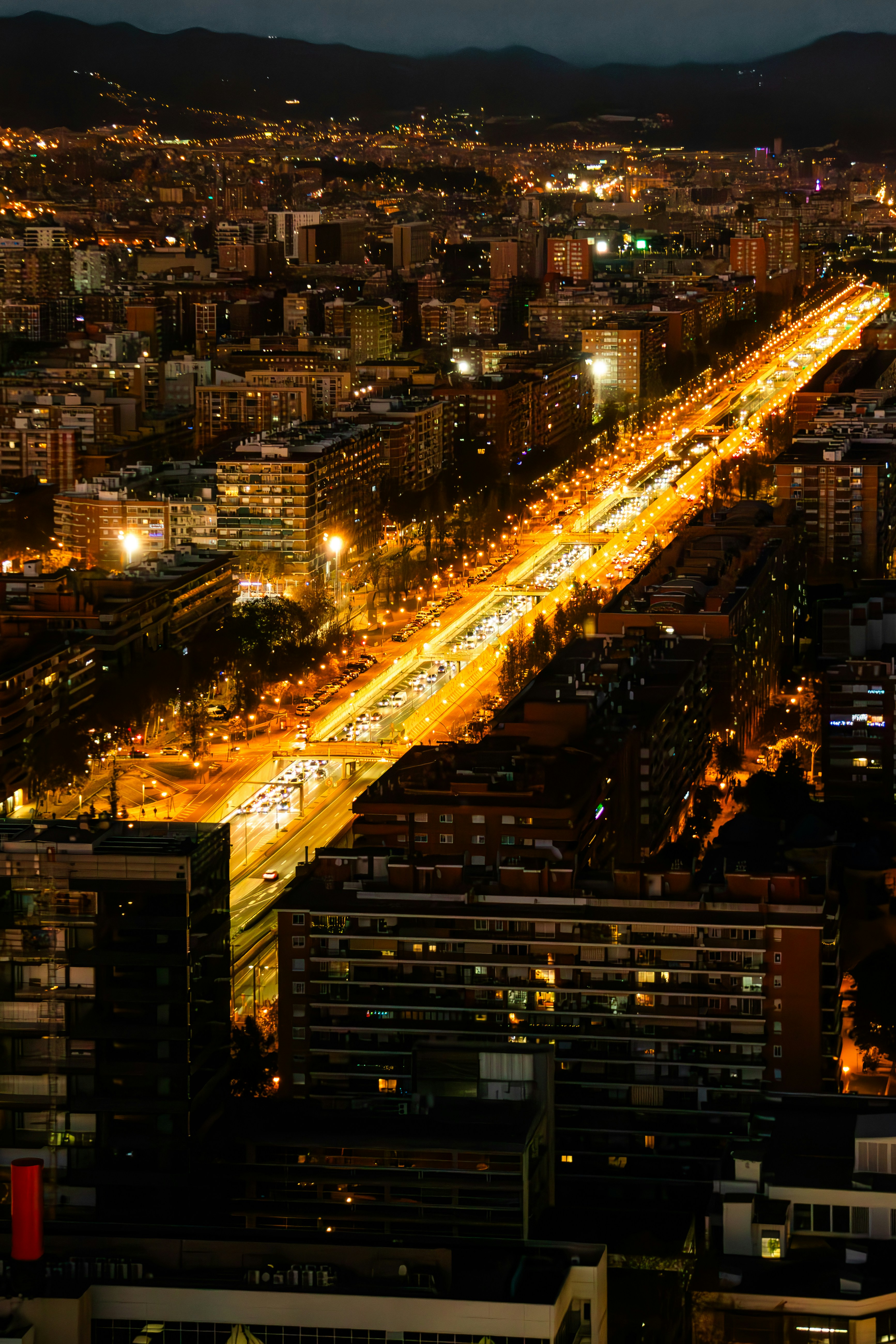 A view of a city at night from the top of a building photo – Free ...