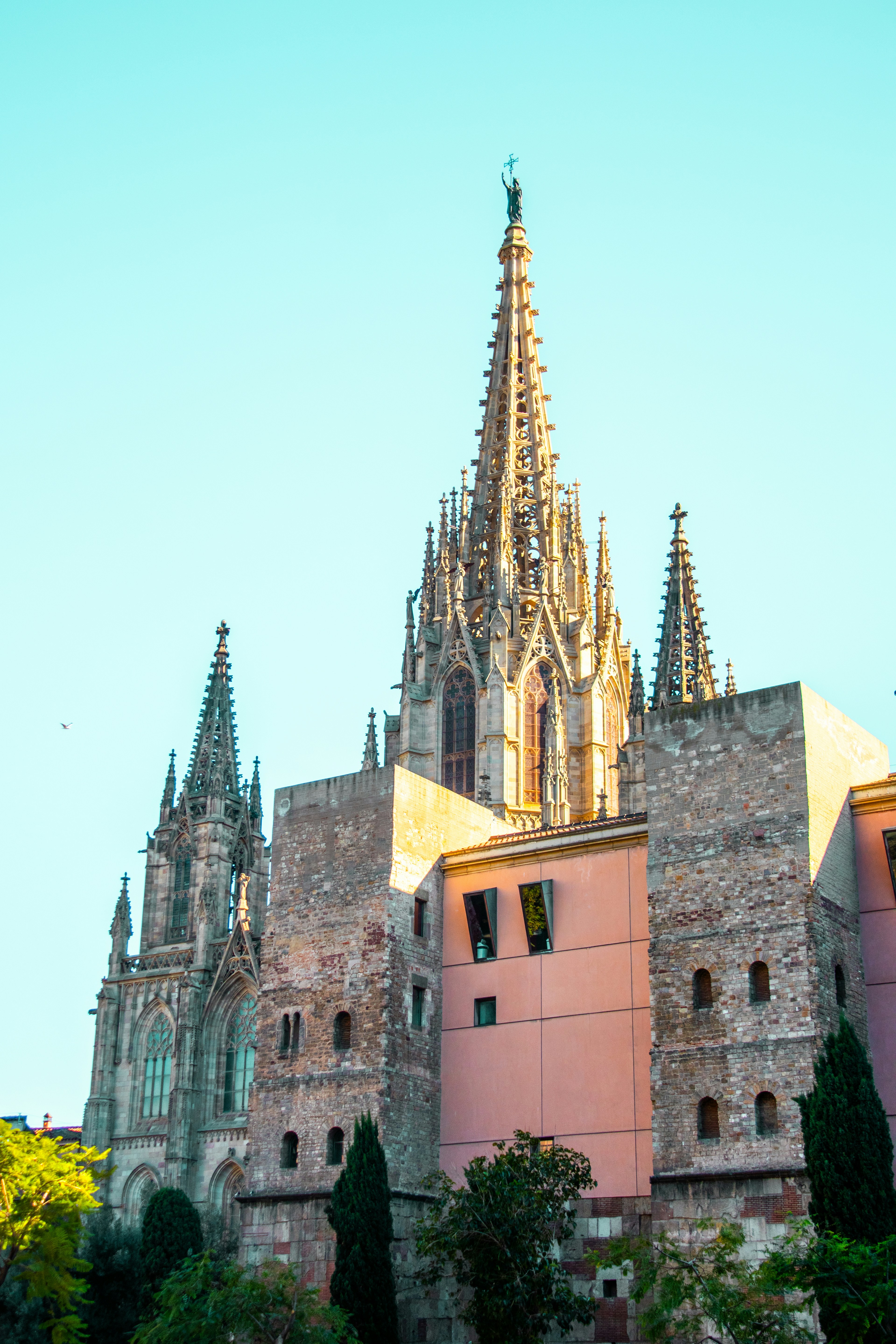 Sunlit Gothic Crown: Spires Soar Over a Brick Cathedral