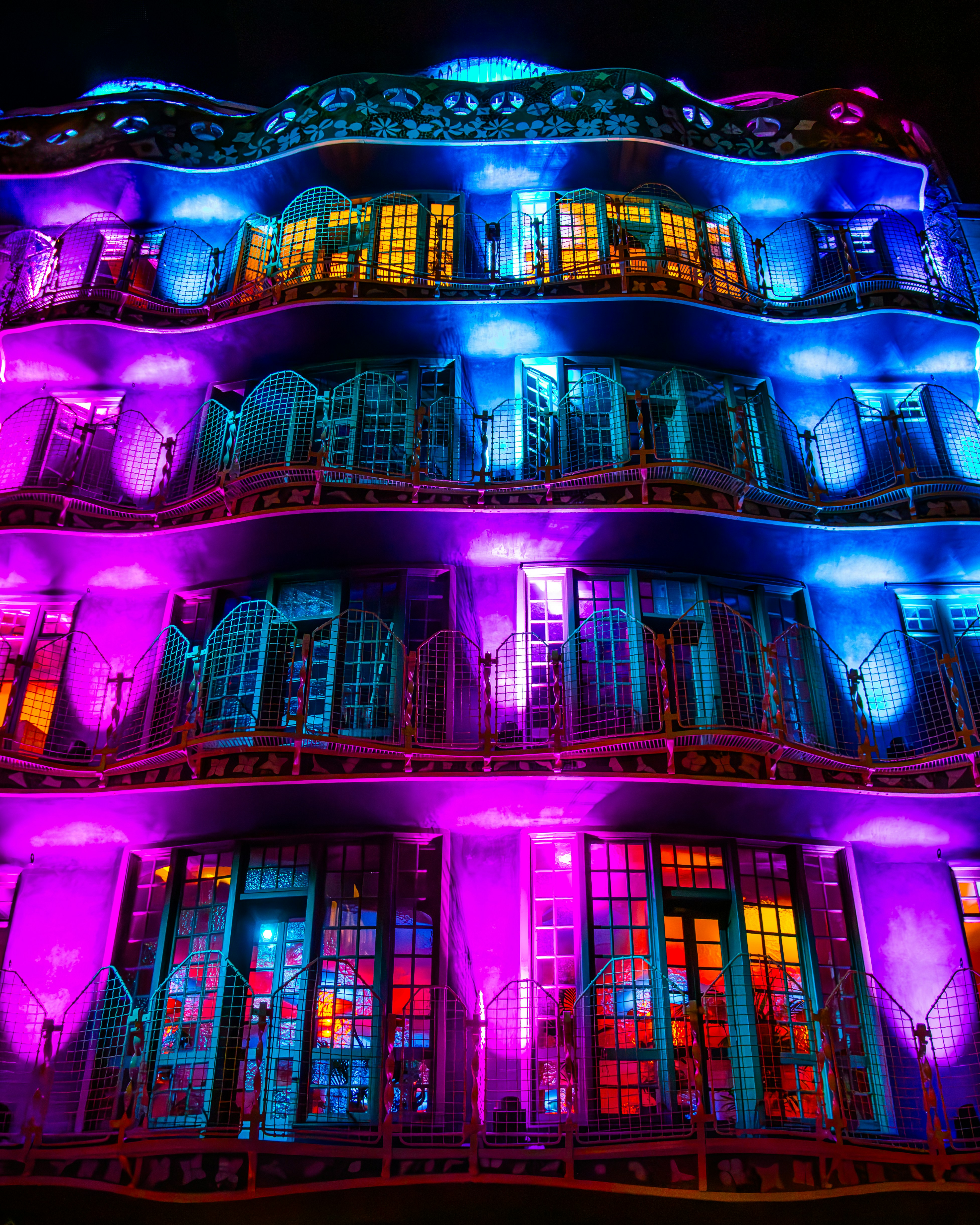 Neon Facade: Curved Balconies Bathed in Electric Hue