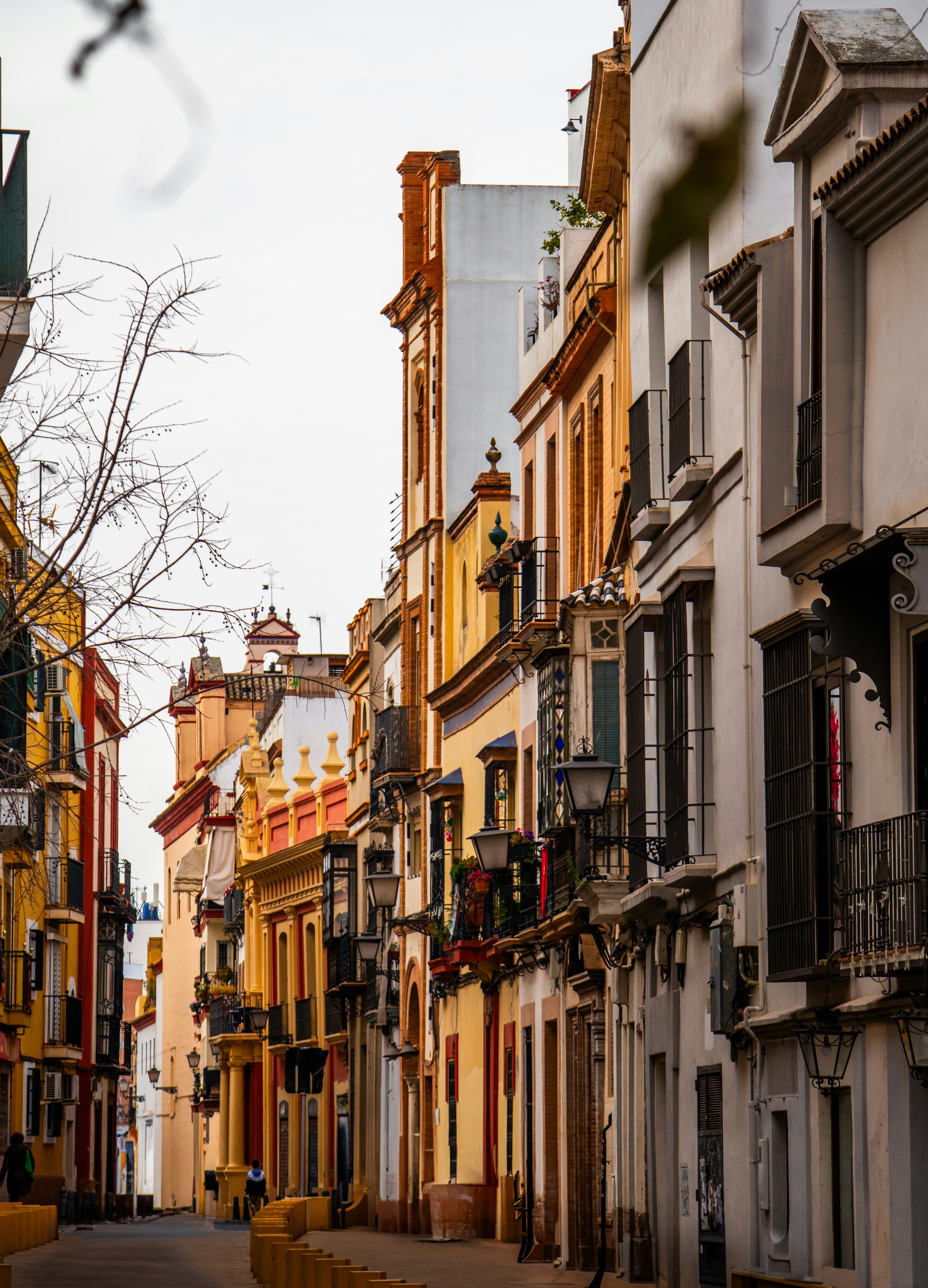 A narrow city street lined with tall buildings photo – Free Urban Image ...