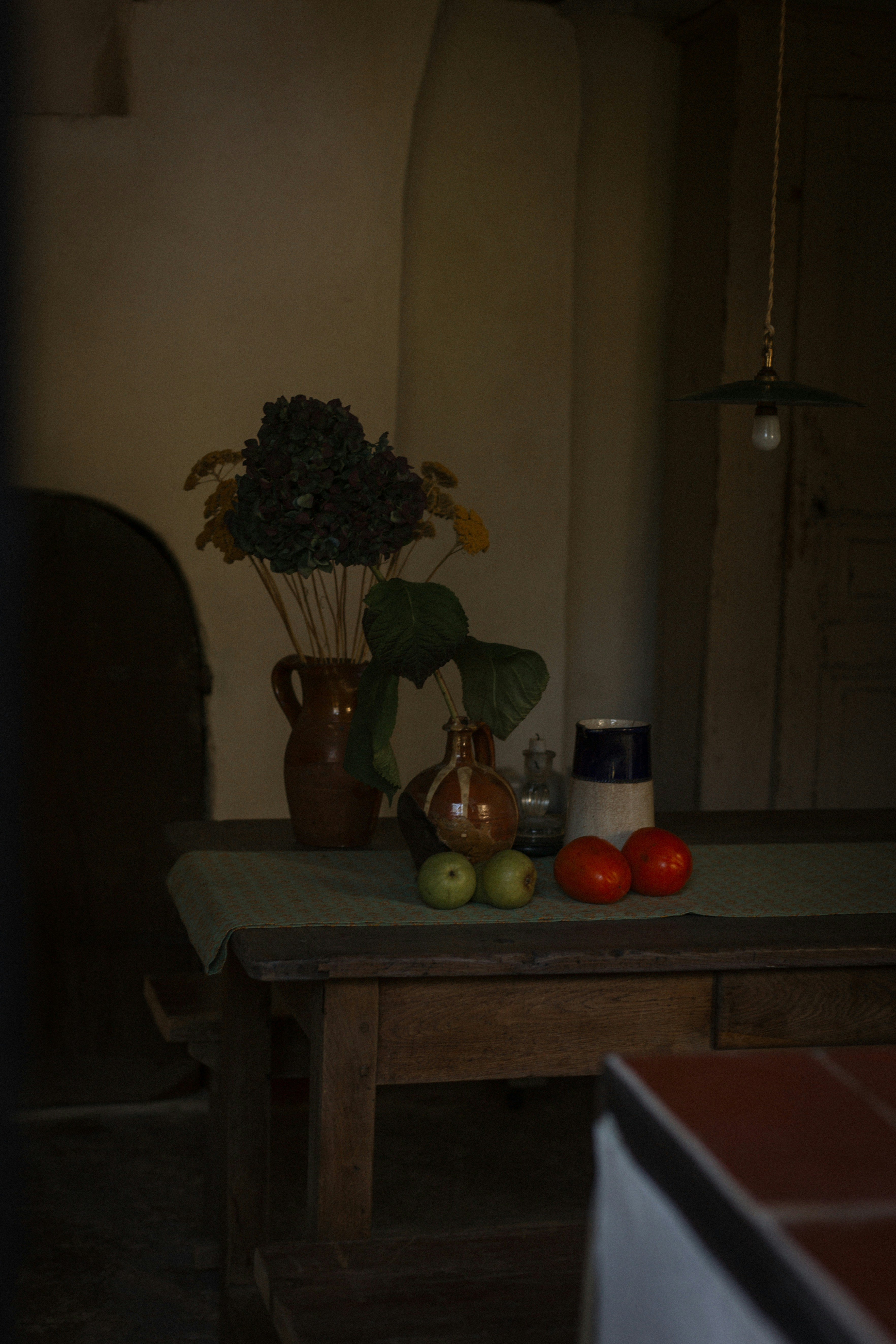 Rustic Dusk Still Life: Hydrangeas, Ceramic Jugs, and Fruit