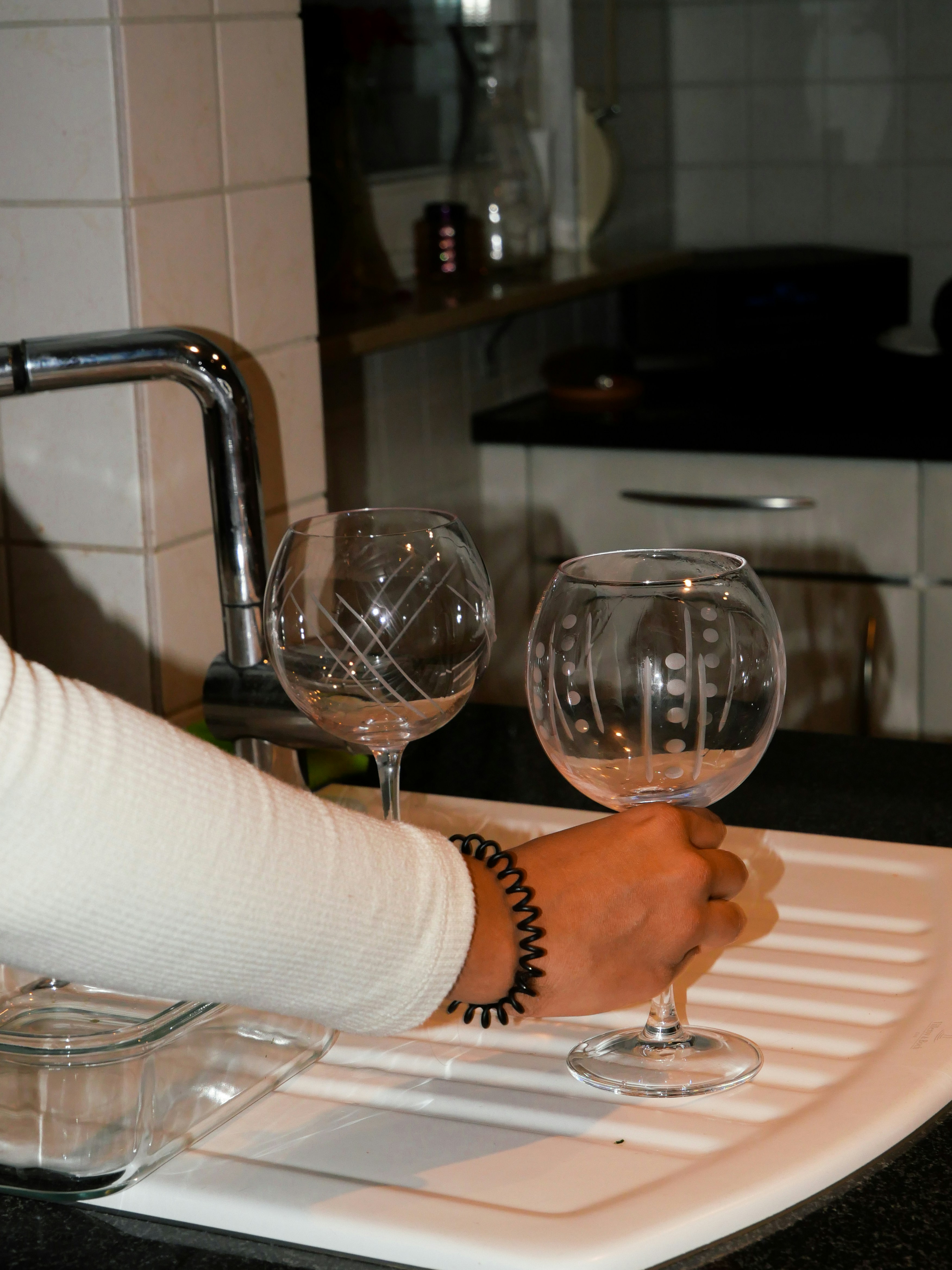 A person holding a wine glass in their hand