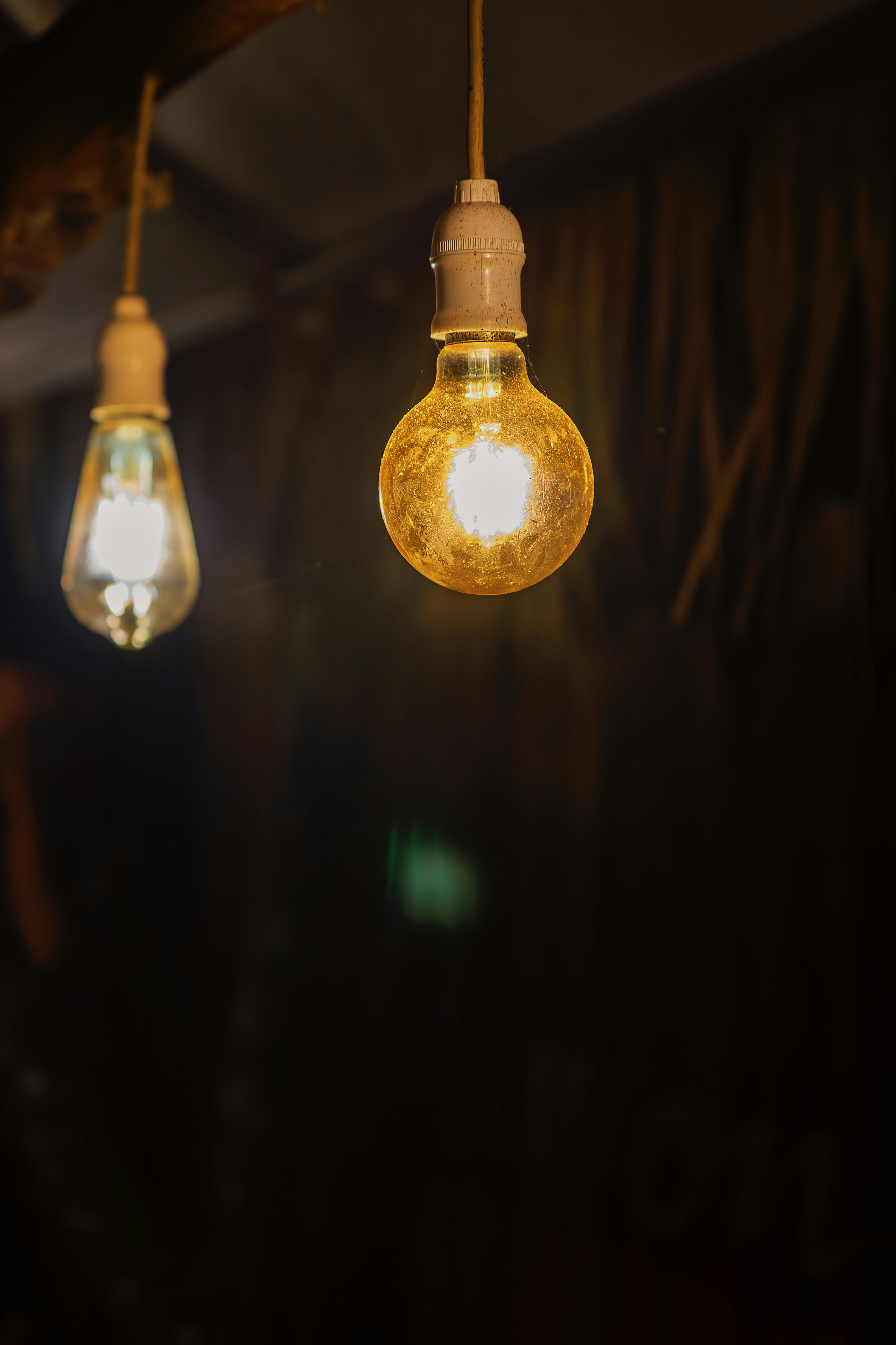 A couple of light bulbs hanging from a ceiling photo – Free Trawas ...