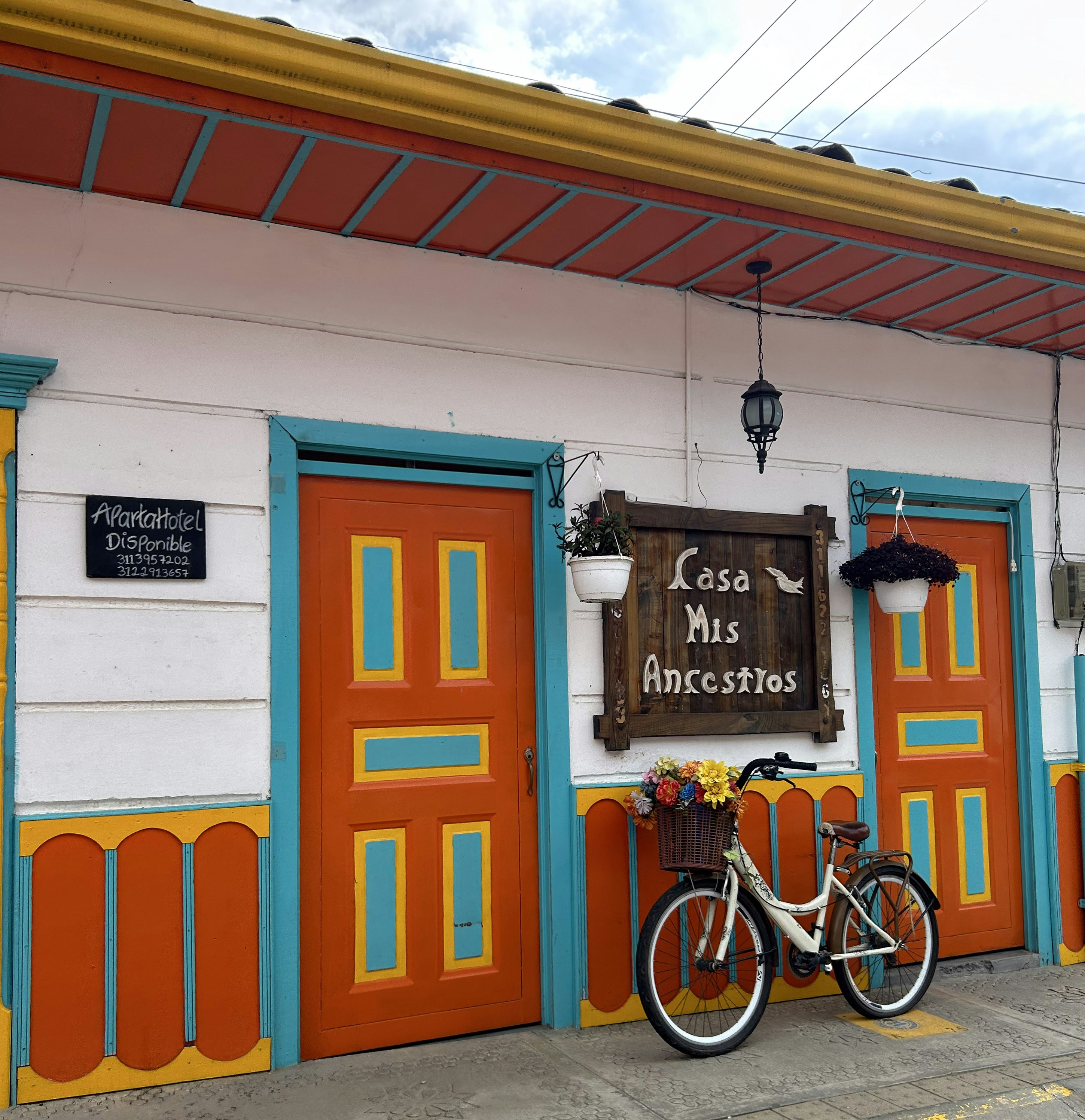 Casa Mis Ancestros: A Rainbow Facade Framing a Quiet Bicycle