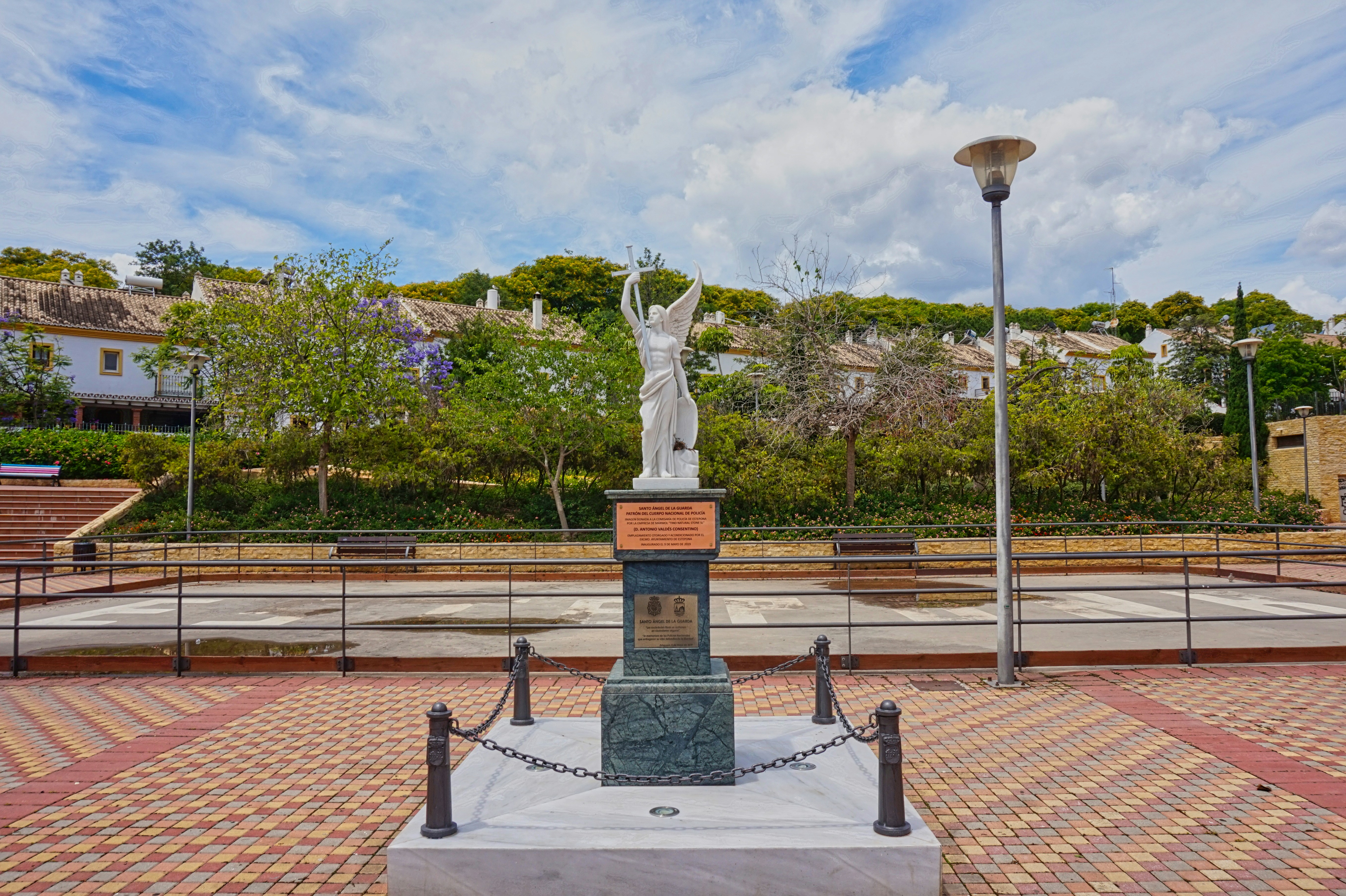 Centerpiece of Stone: A Statue Rising over a Brick Plaza