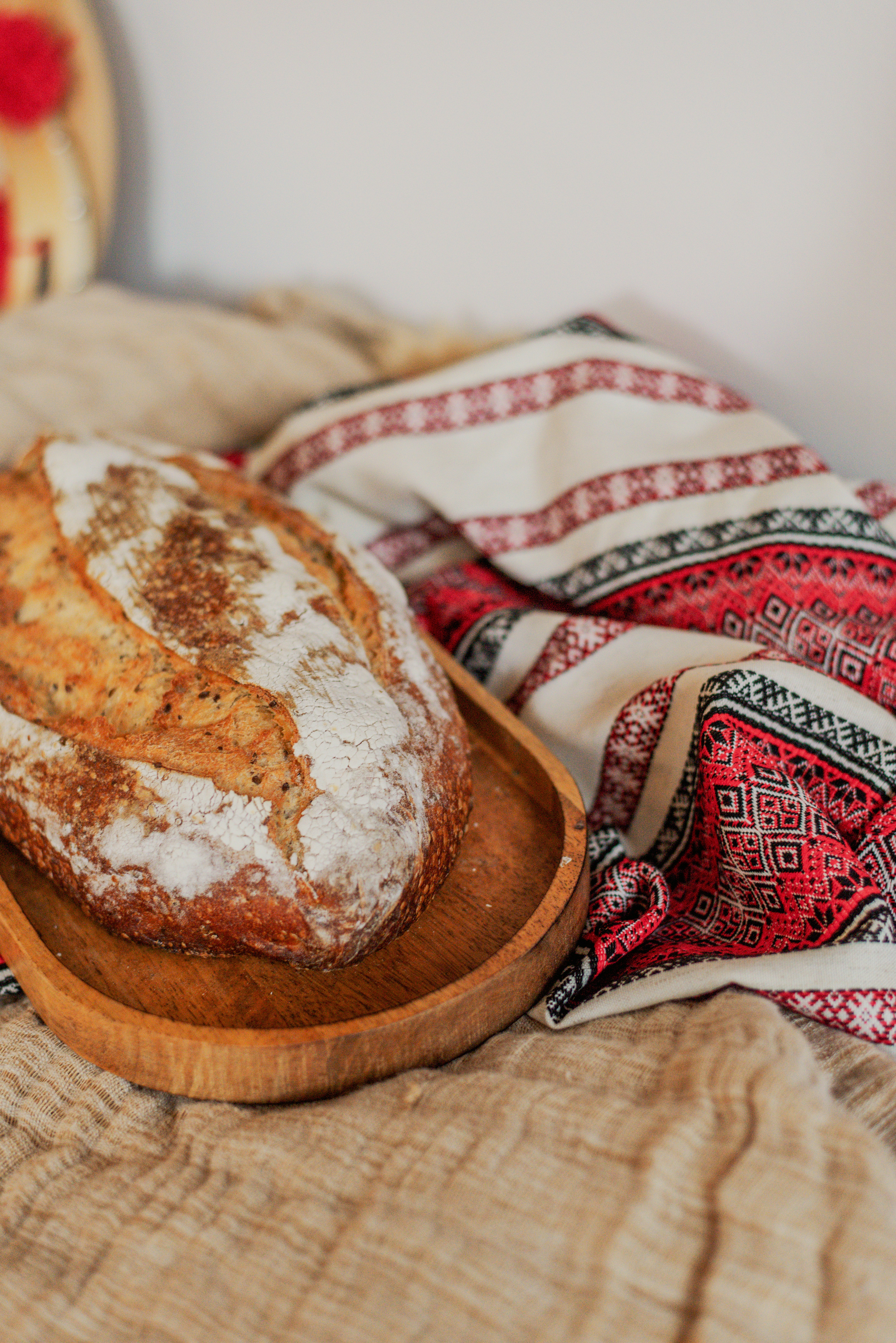 Crust Crown on Wood: A Rustic Bread Moment Amid Patterned Linen