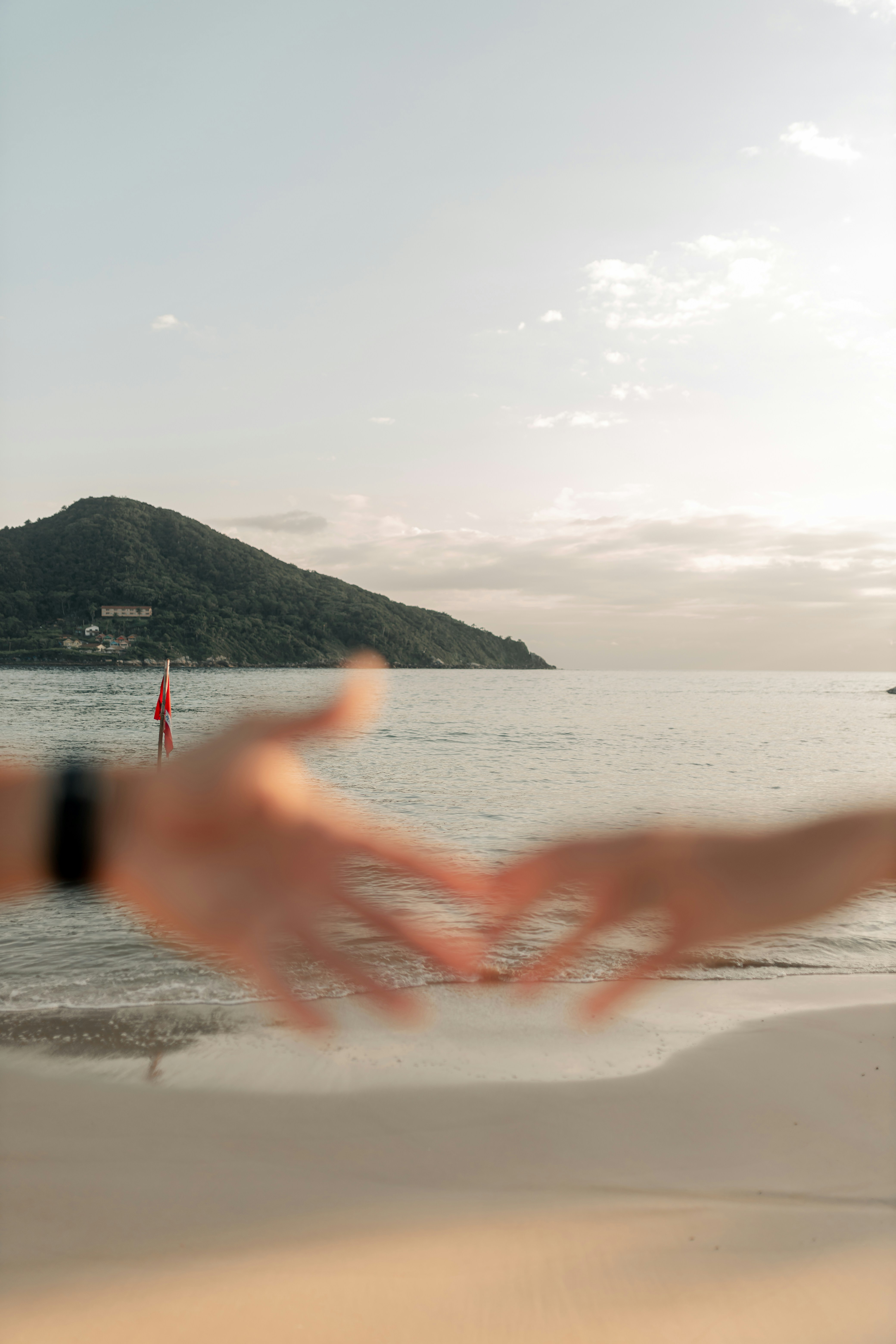 Hands Reaching Across the Sea: A Moment of Connection at Sunset