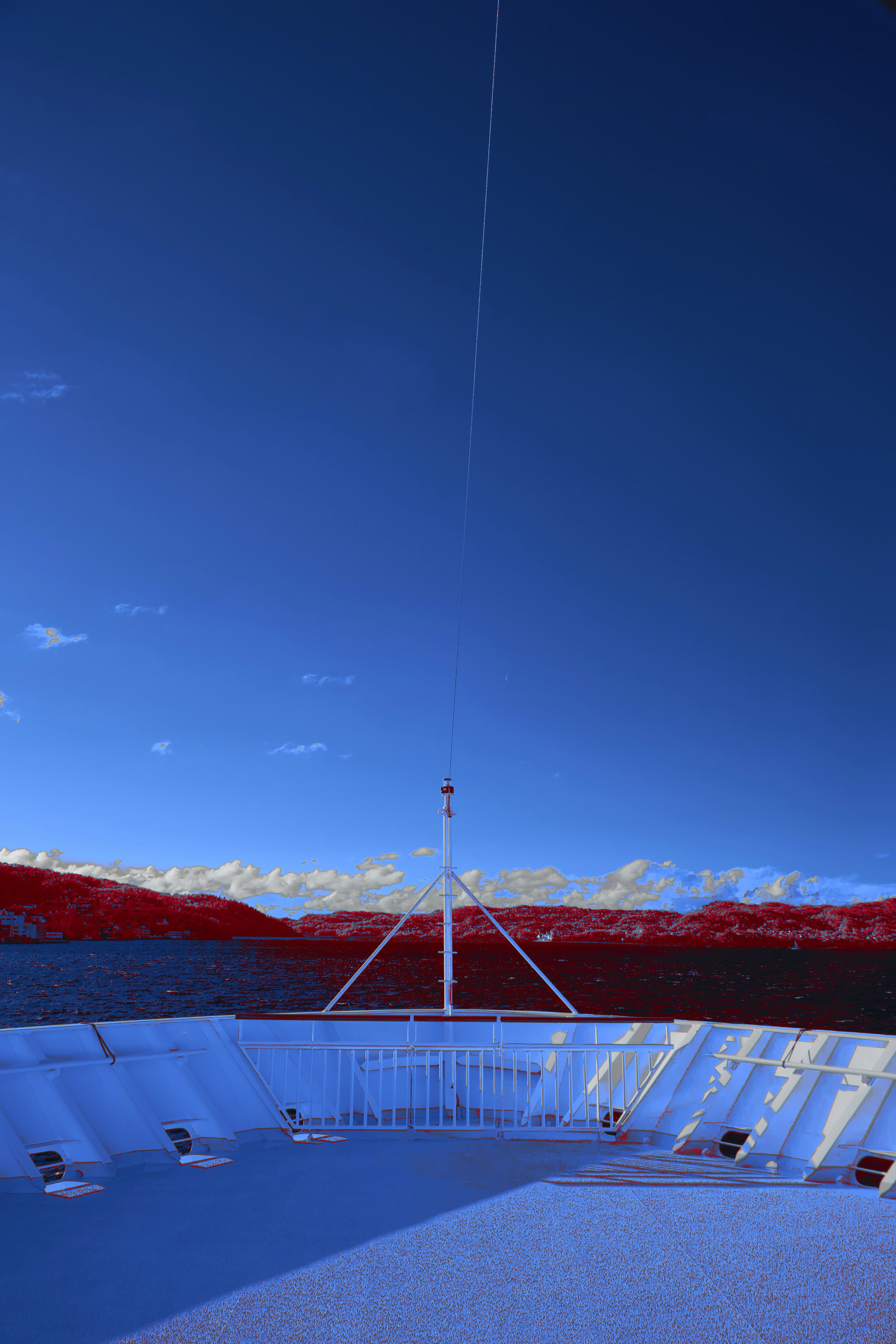 A blue sky with a plane flying in the distance photo – Free Nature ...