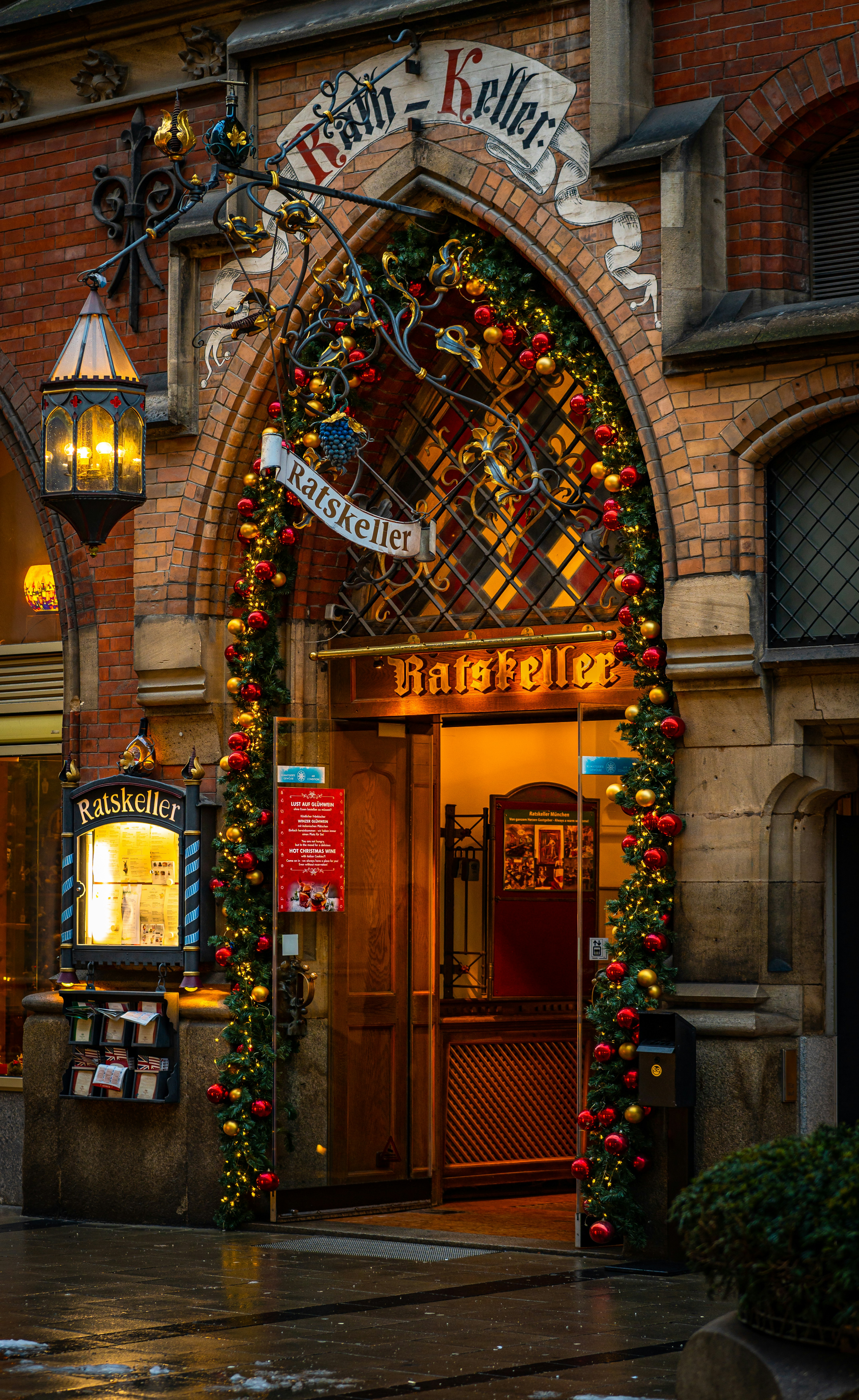 Warm Glow Through a Garland-Framed Arch at the Ratskeller Entrance
