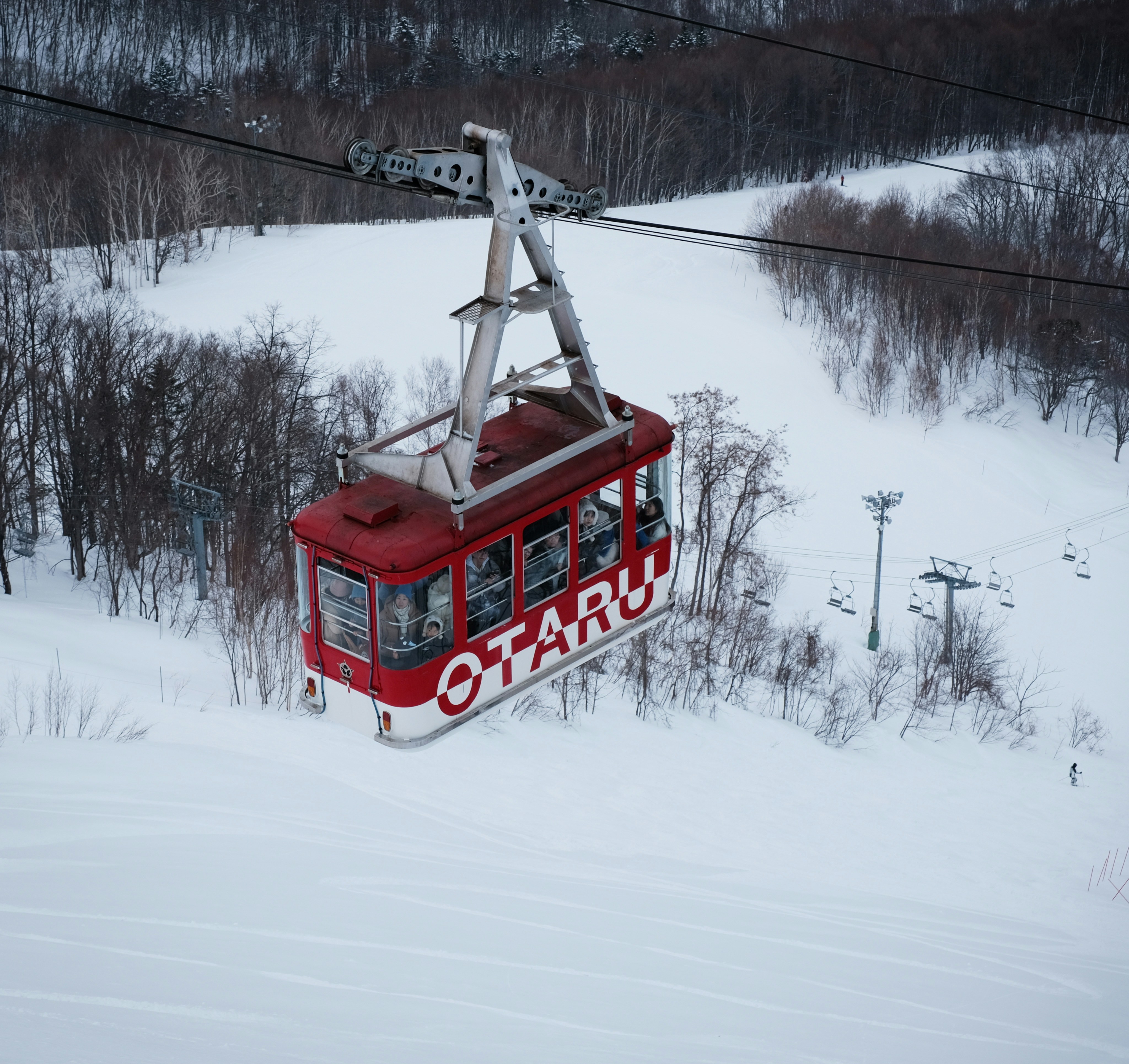 Crimson Cable Car Climbing a Snow-Blanketed Otaru Slope