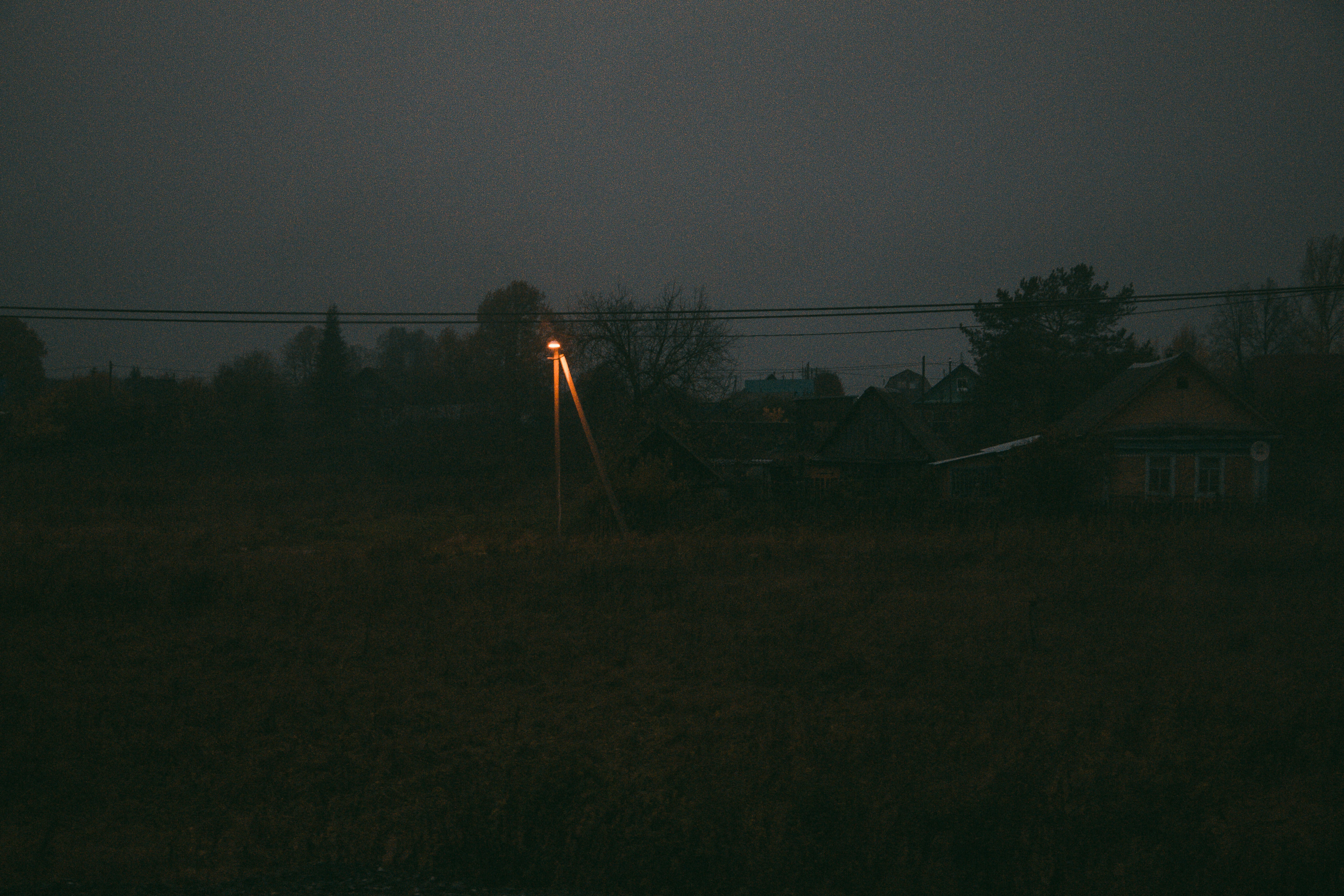 Lone Streetlamp Tracing Orange Light Across a Quiet Rural Field