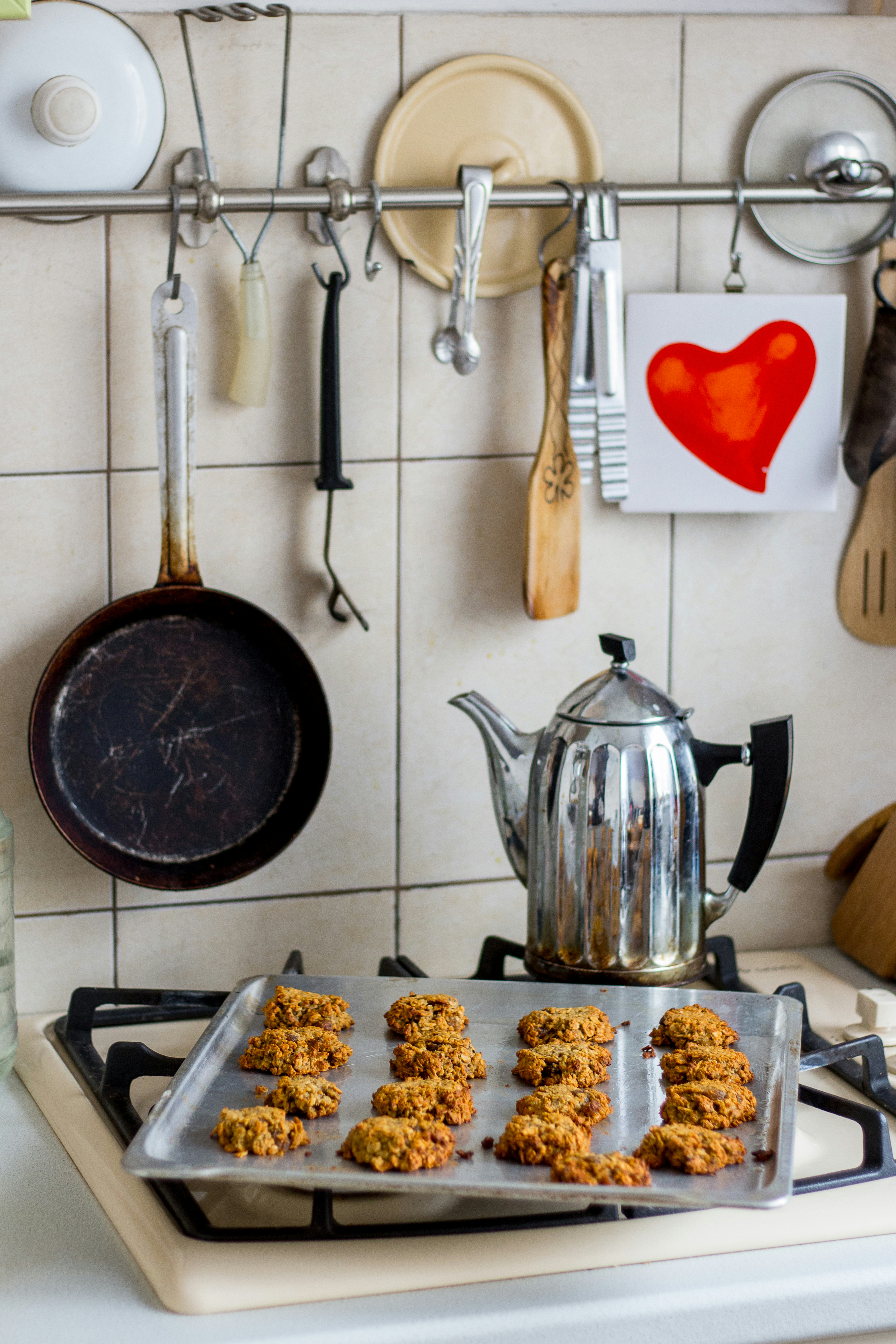 A stove top with a pan of cookies on it photo – Free Red Image on Unsplash