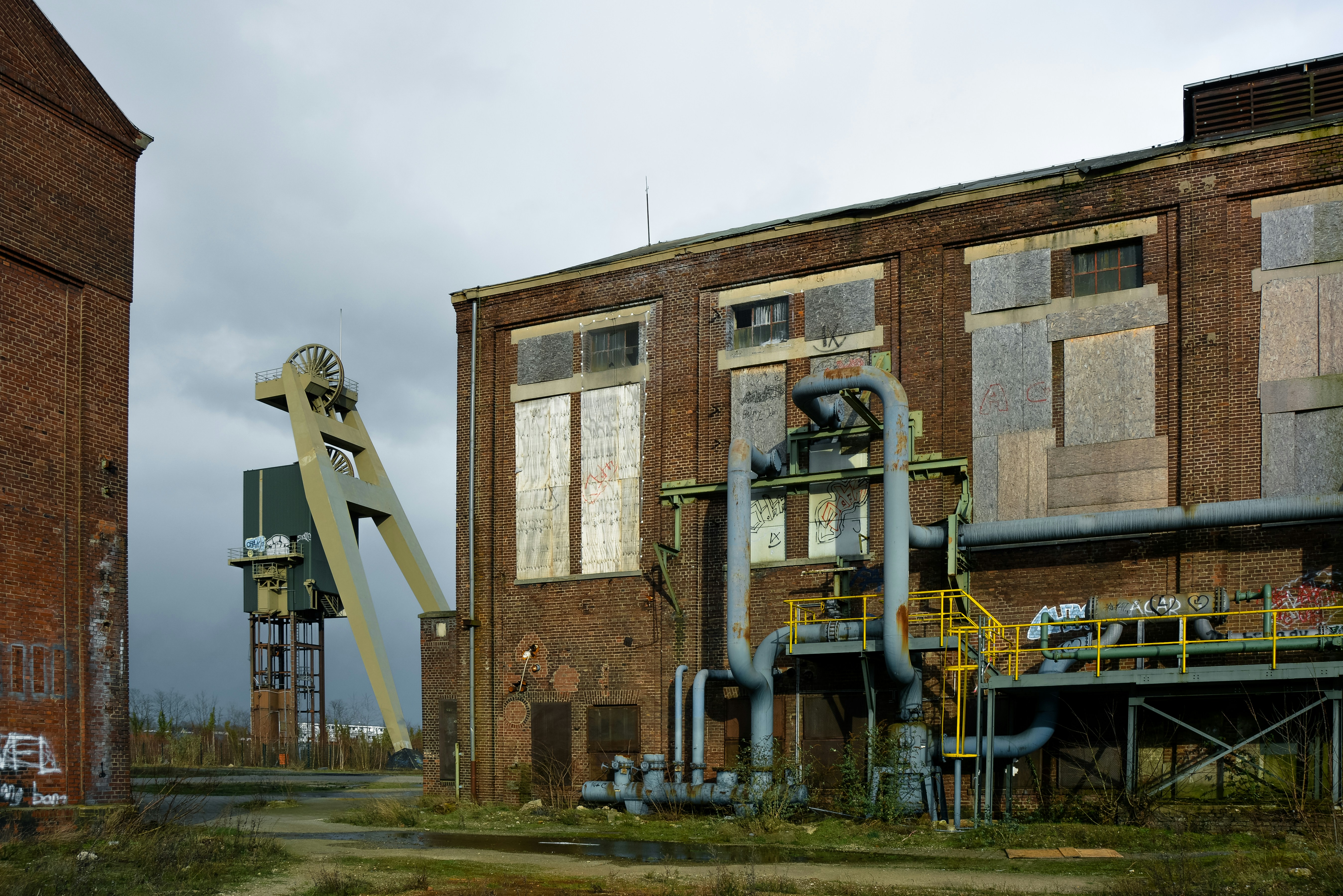 An old factory building with a crane in front of it photo – Free ...