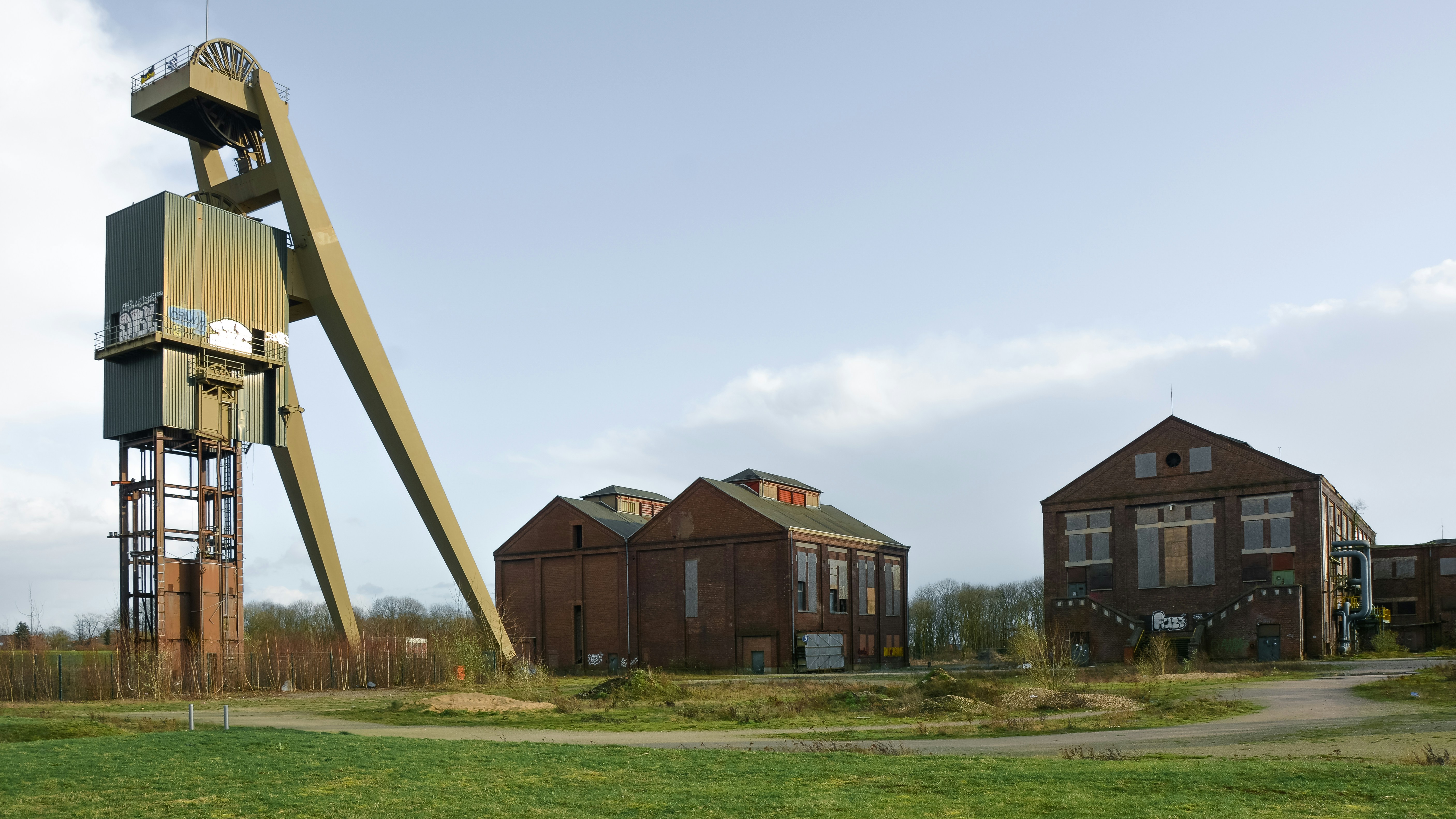 The Leaning Crane Over a Row of Abandoned Brick Mills