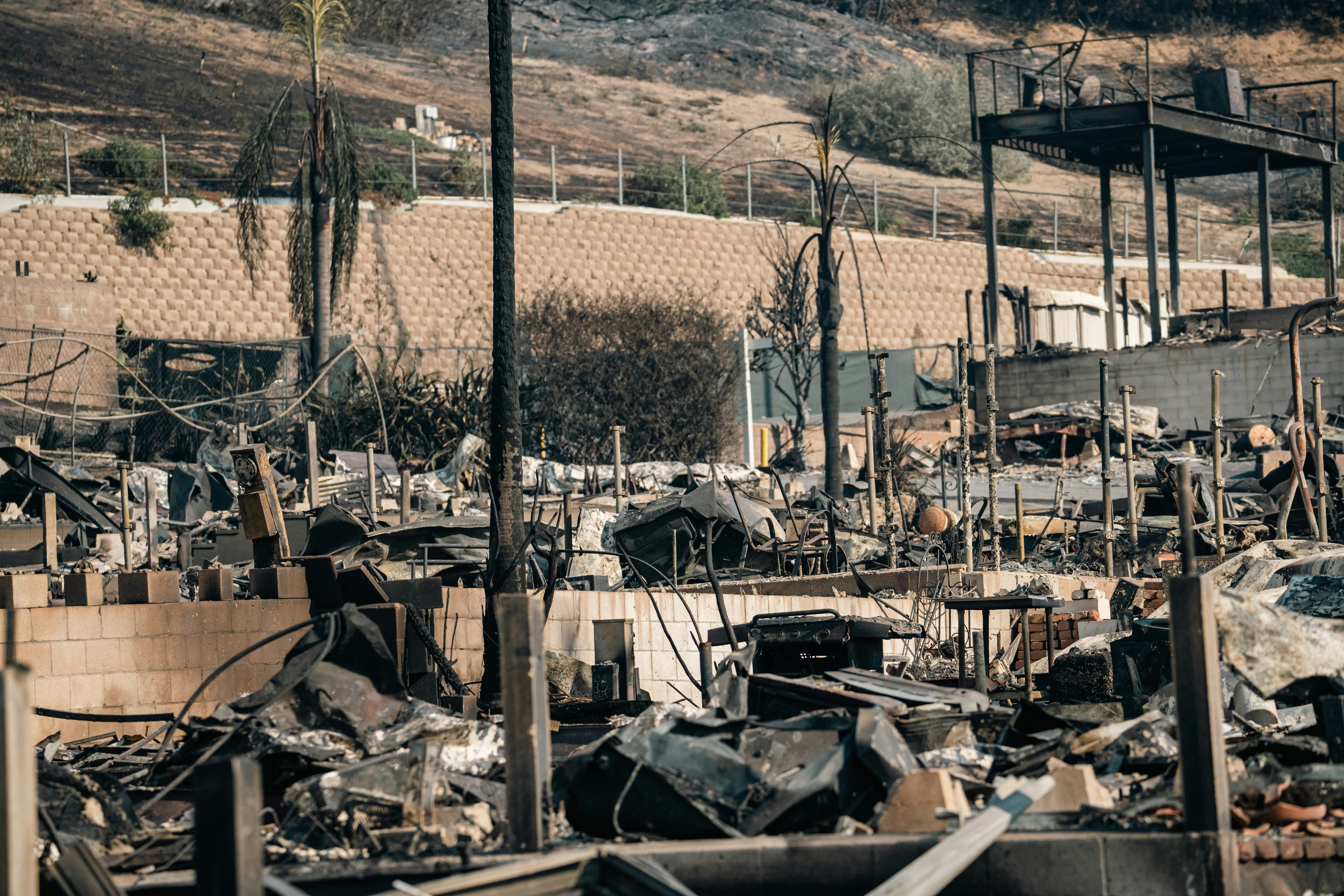 A large pile of junk sitting next to a hillside photo – Free Current ...