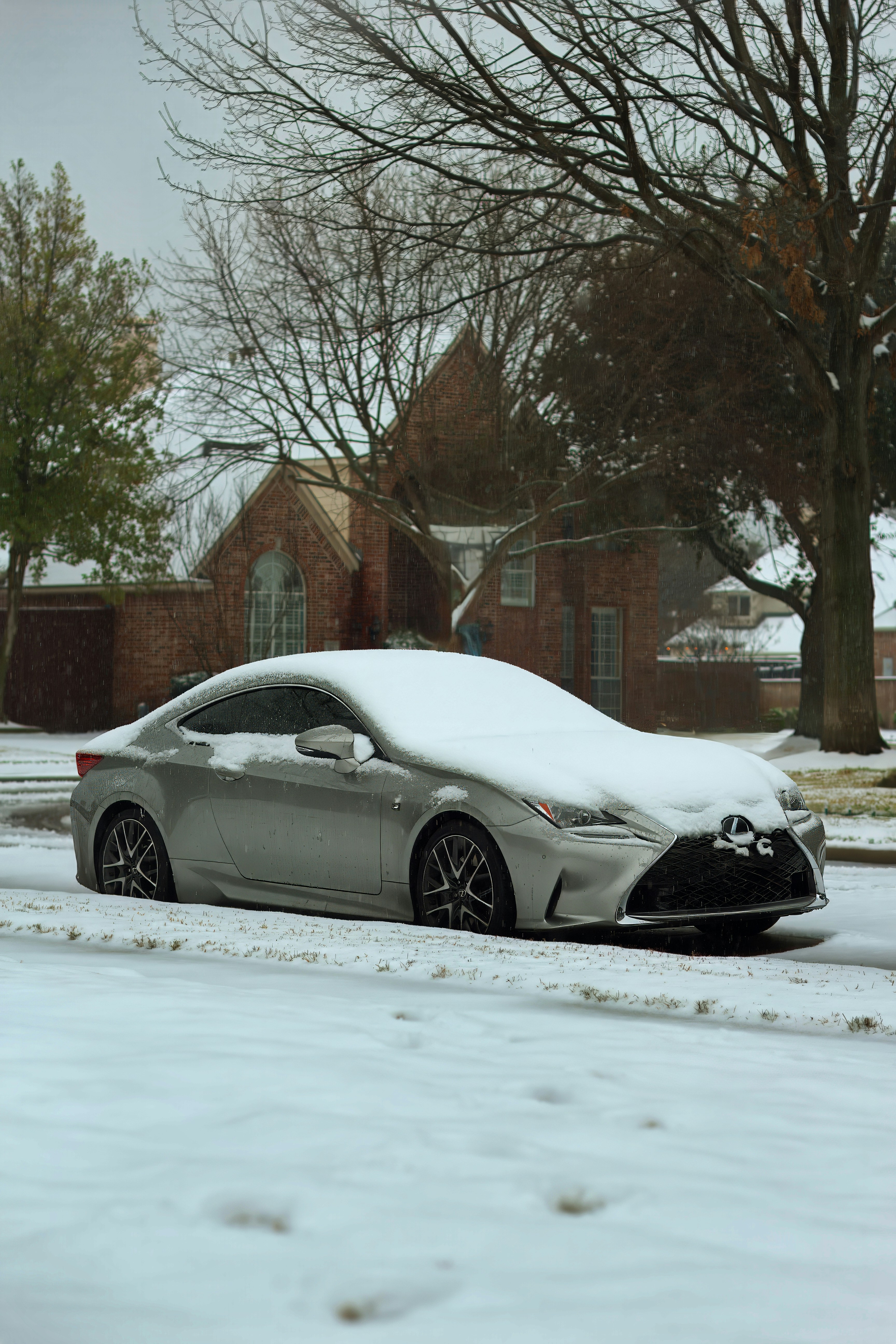 Snow-Covered Sedan Resting in a Quiet Suburban Winter Morning