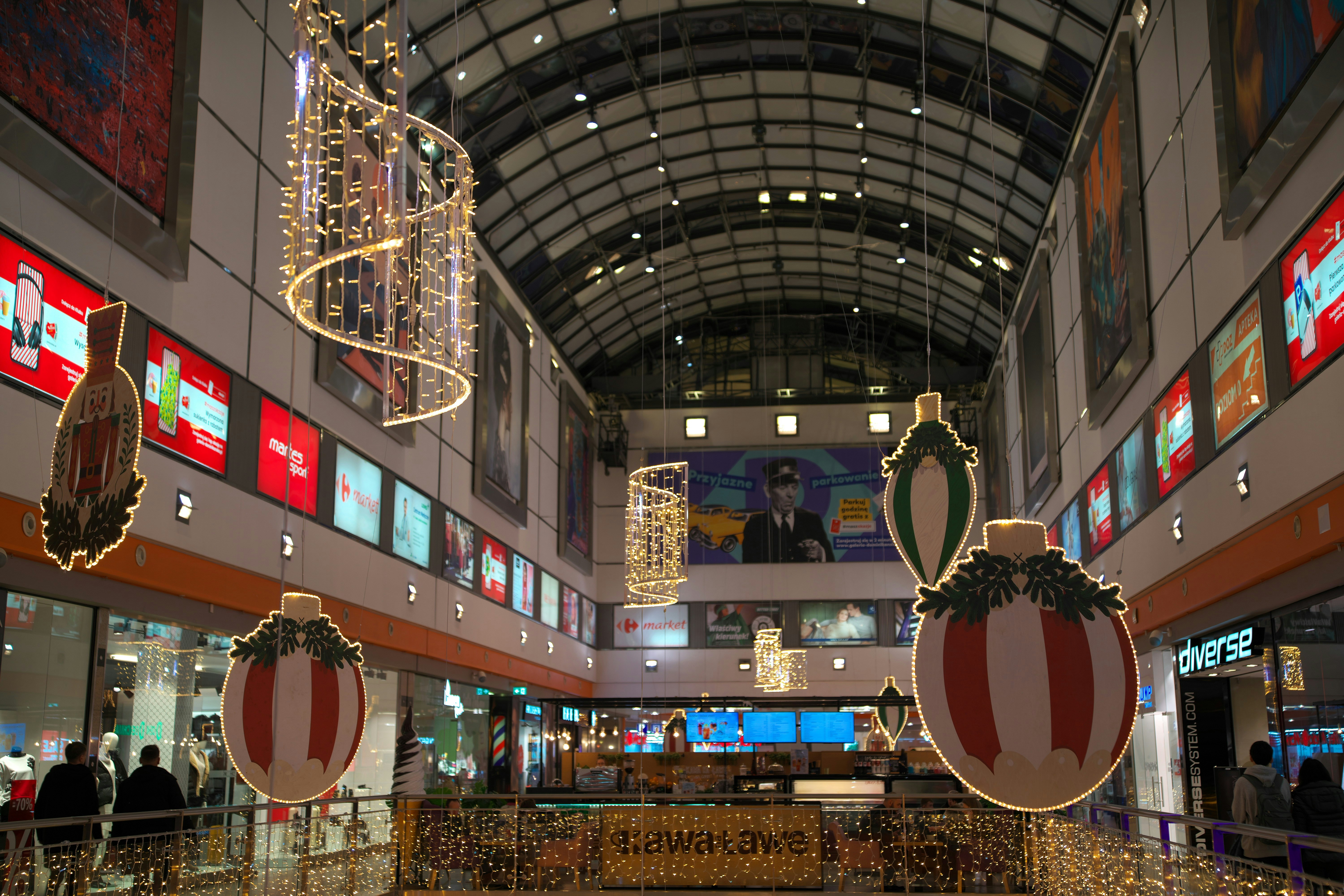 A shopping mall filled with lots of lights and decorations photo – Free ...