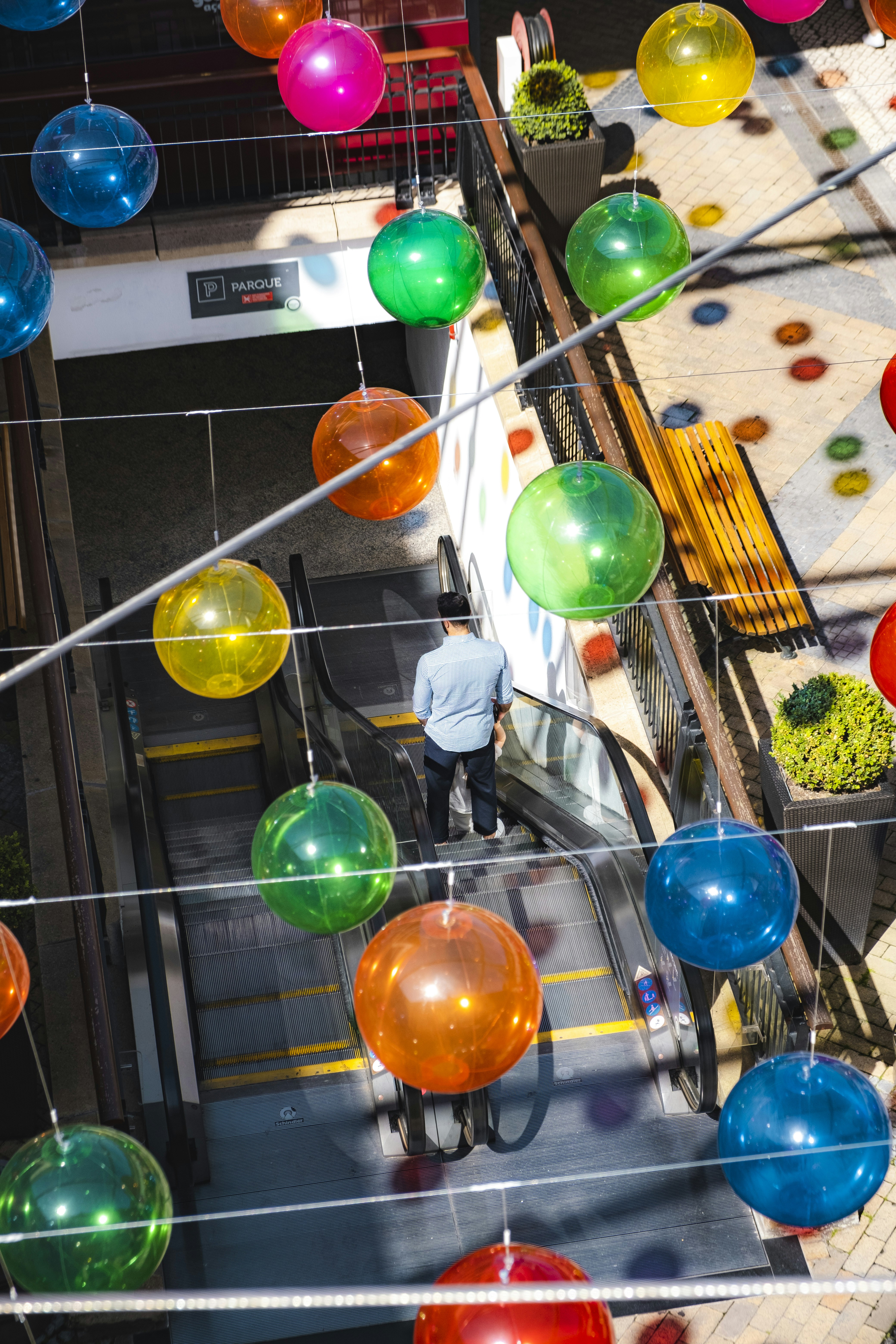 Floating Orbs over a City Escalator
