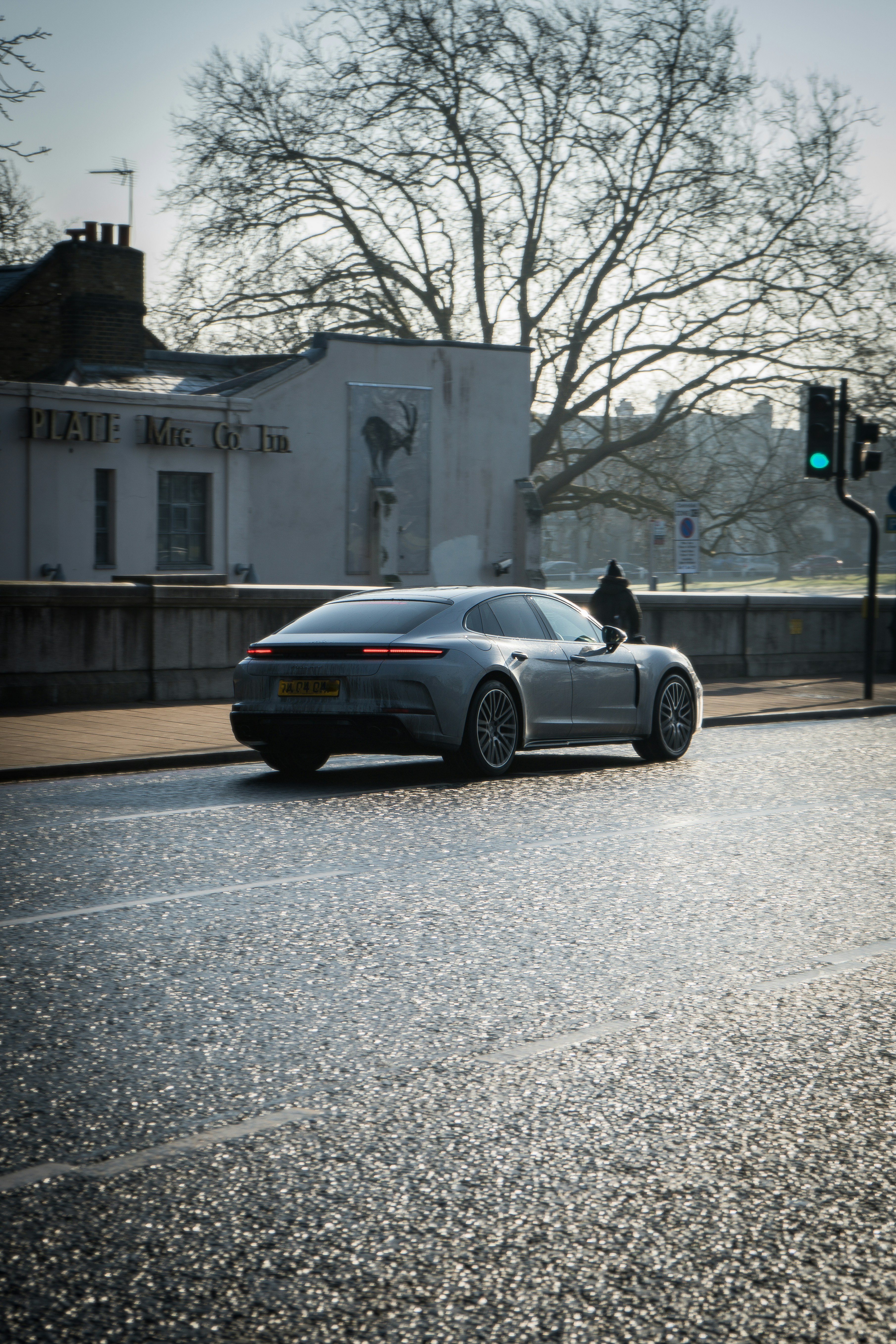 Luminous Riverside Run: A Silver Coupe Pausing by the Water