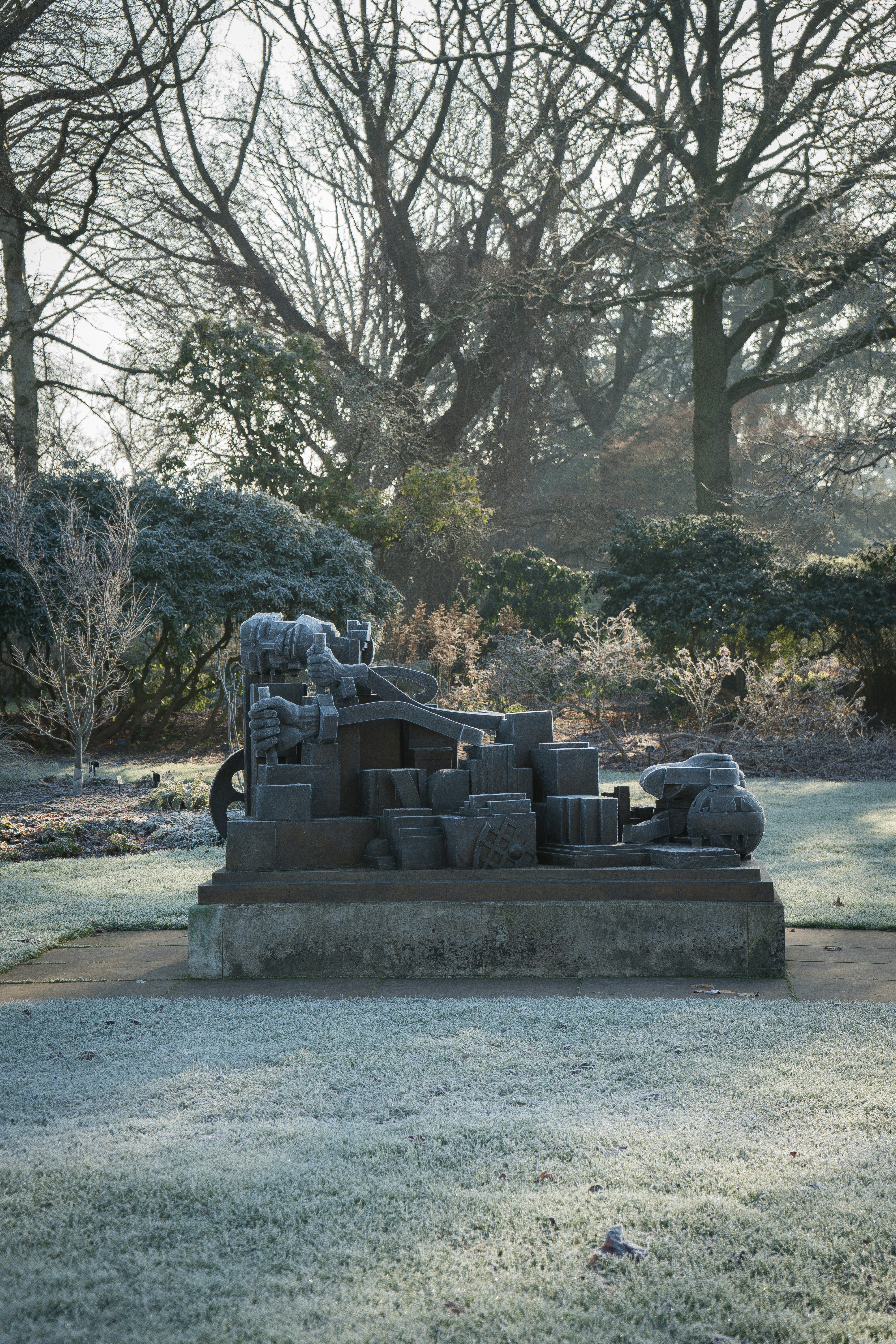 Industrial Reverie: Frosted Machinery Sculpture in a Quiet Garden