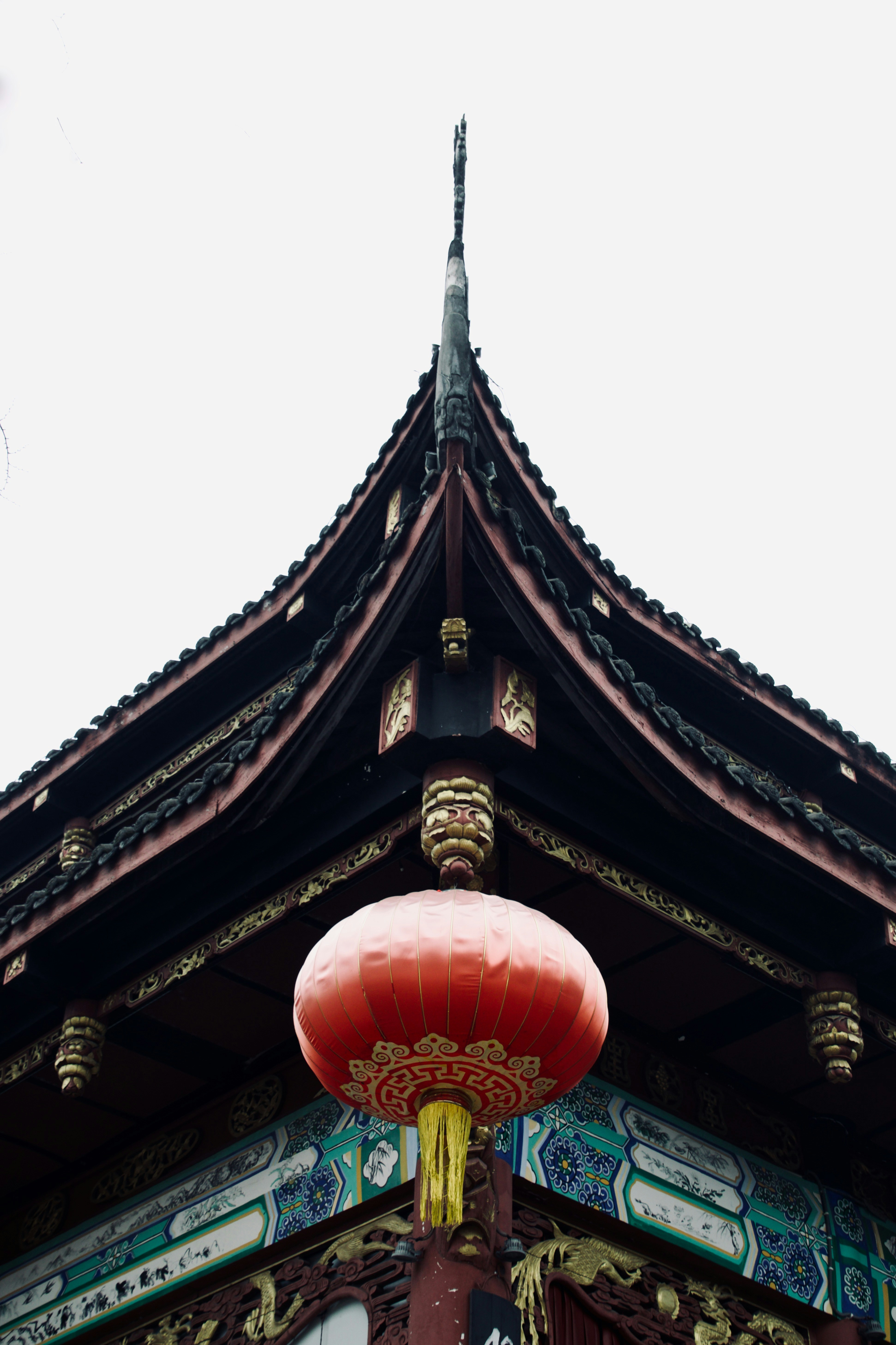 A tall building with a red lantern in front of it photo – Free Prayer ...