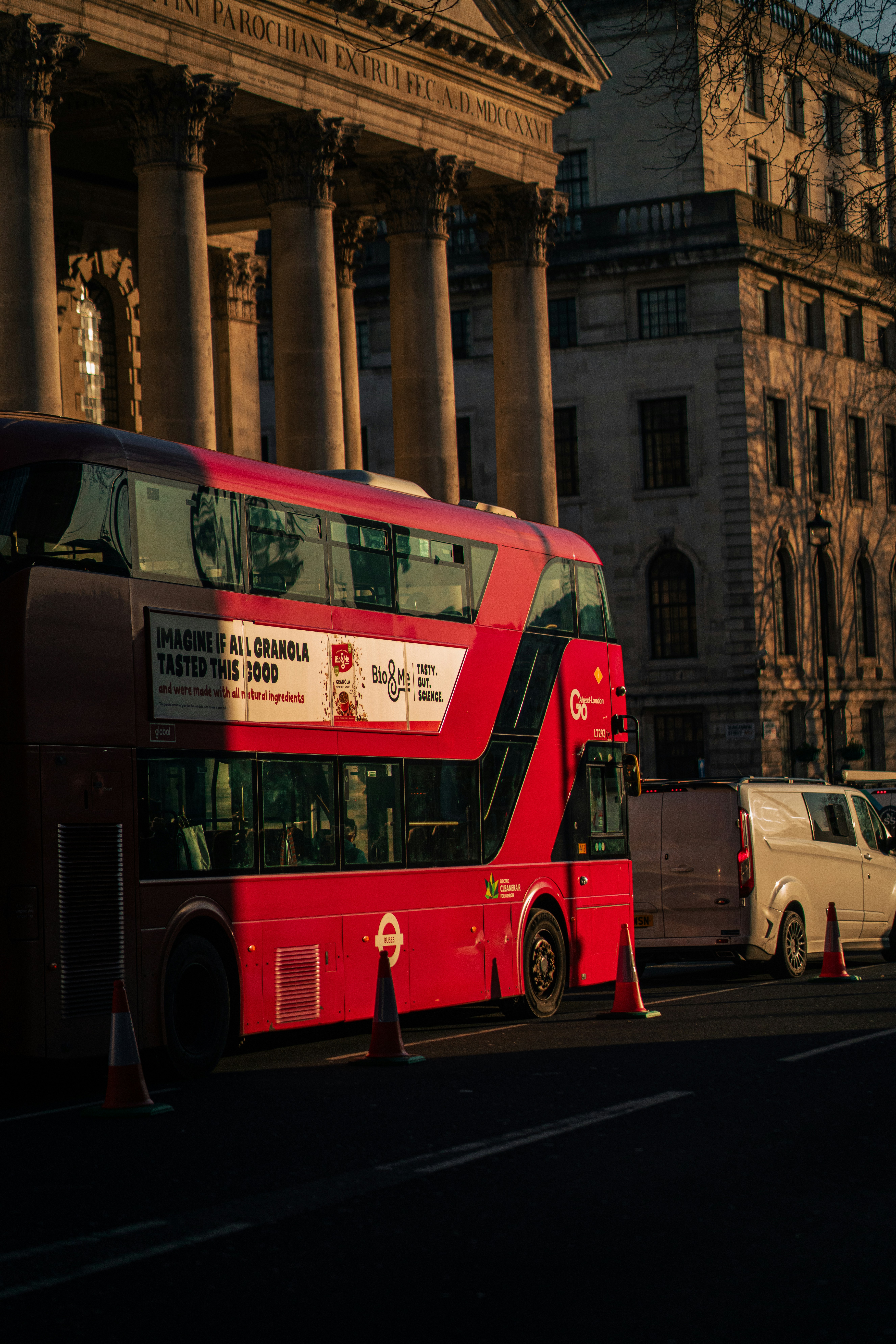 A red double decker bus driving down a street photo – Free Bus Image on ...