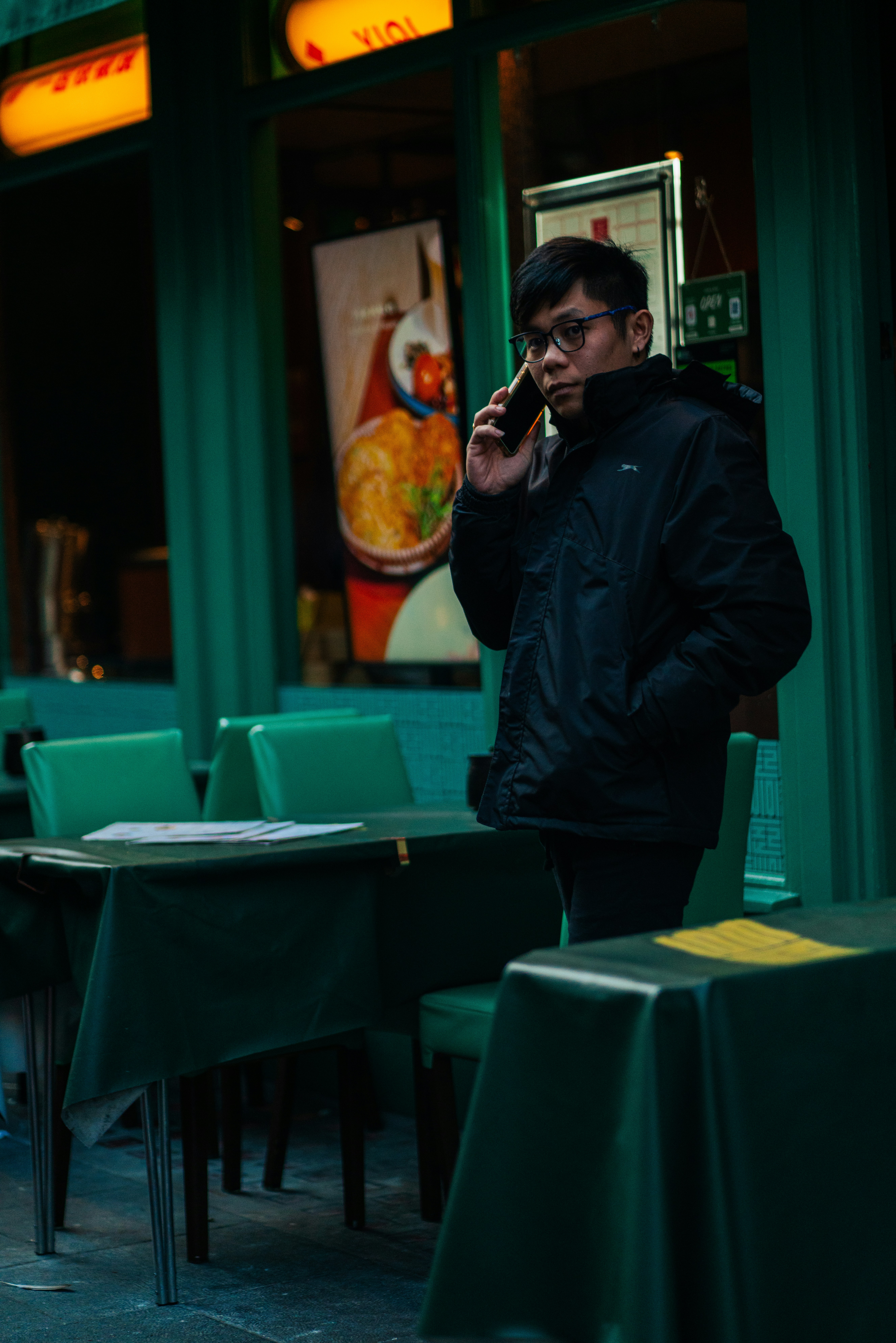 Night Call at the Teal Café: A Quiet Portrait under Neon-Green Glow