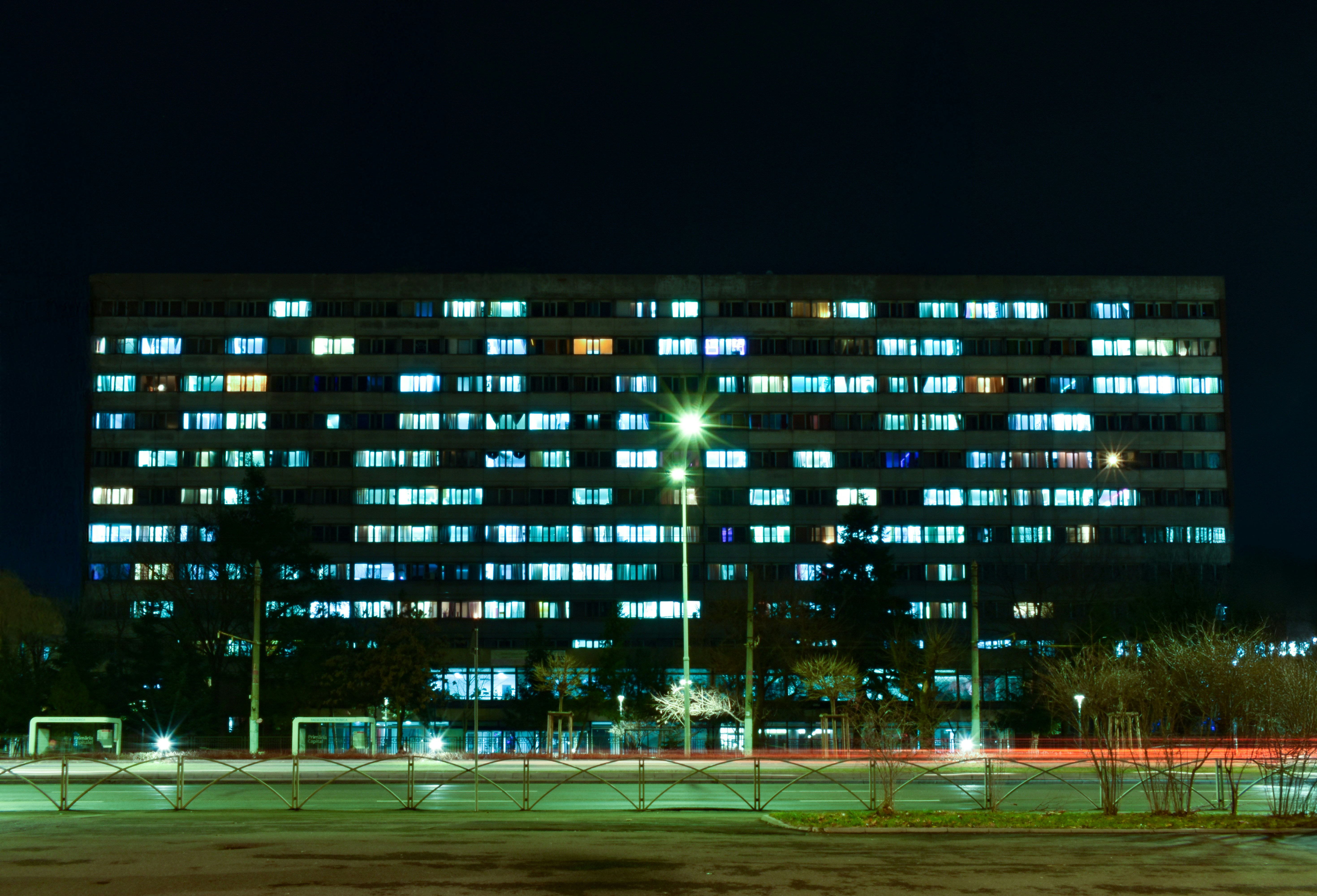 Neon Grid Overwatch: Nighttime Office Block with Light Trails