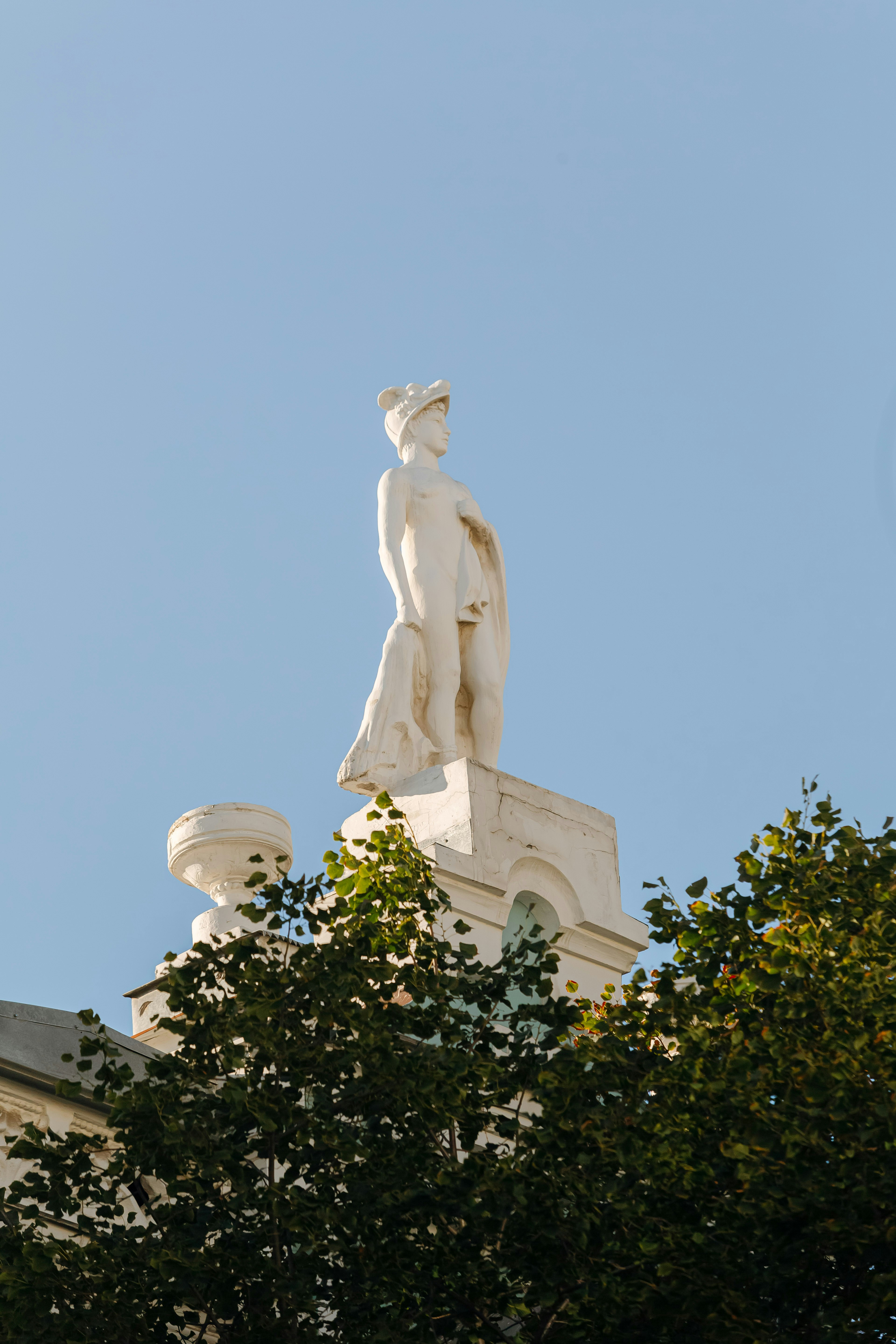 Marble Sentinel on a Rooftop Under a Cobalt Sky