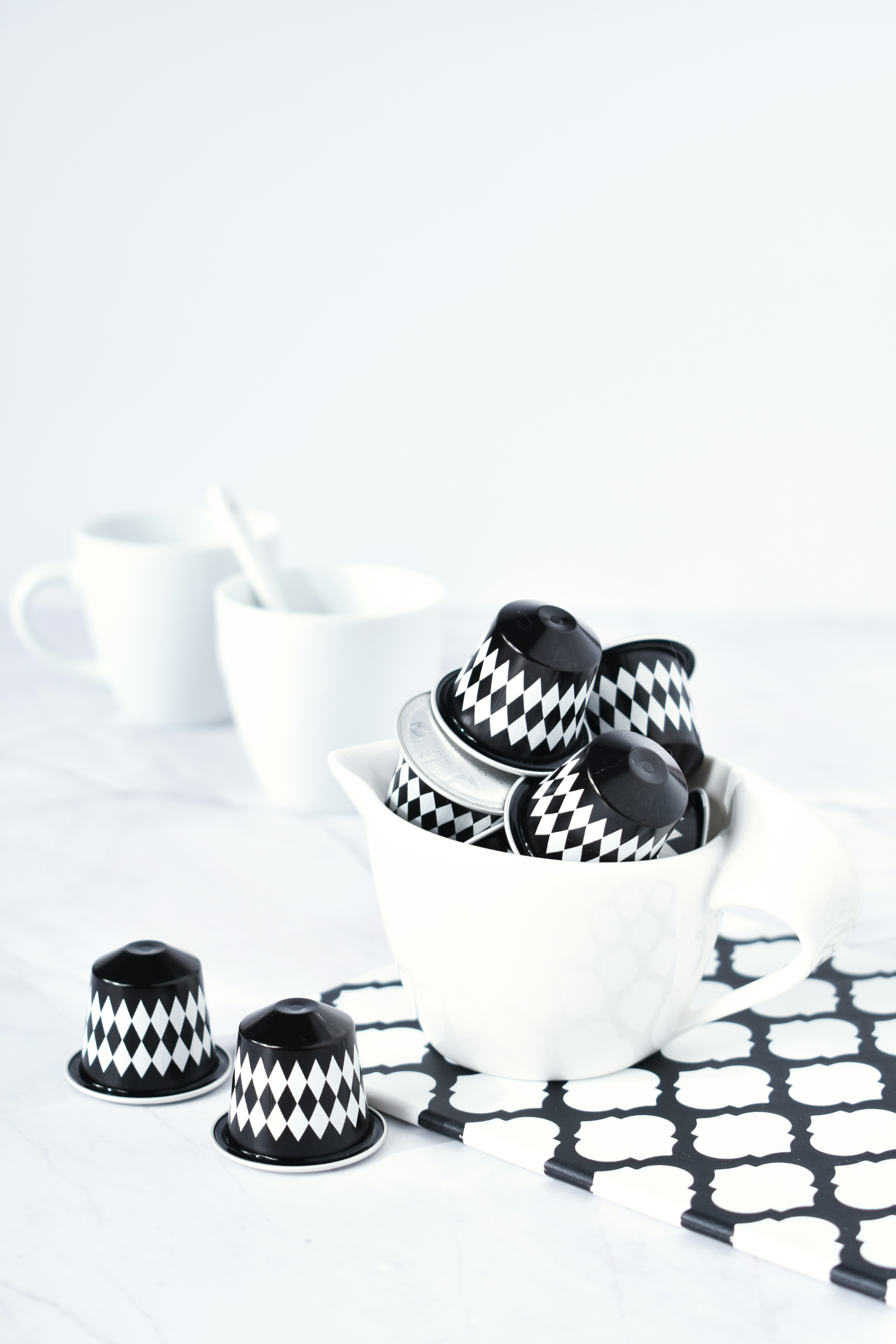 Monochrome Capsule Still-Life: Diamond-Patterned Pods in a Prim White Studio