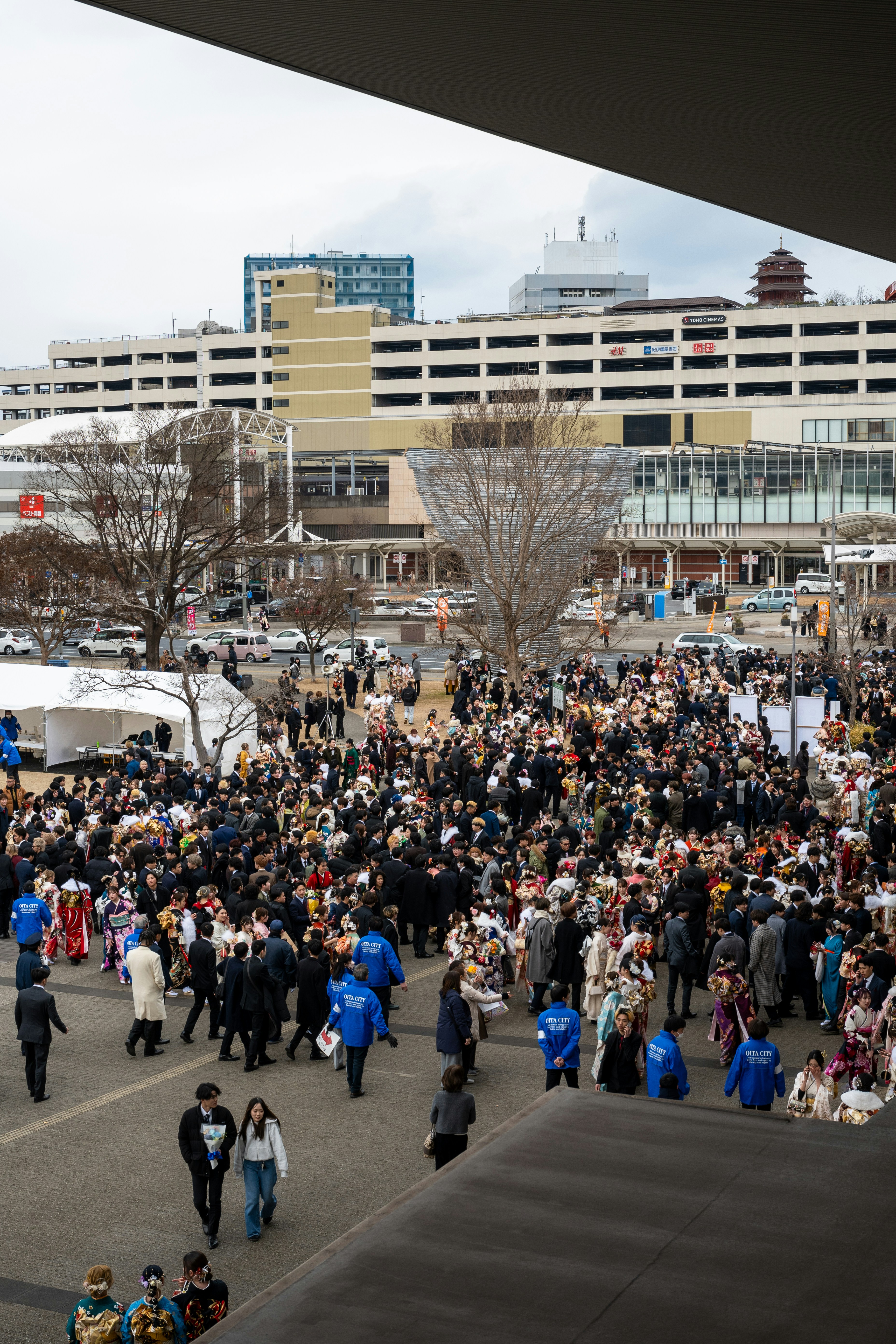 A large crowd of people walking around a parking lot photo – Free Human ...