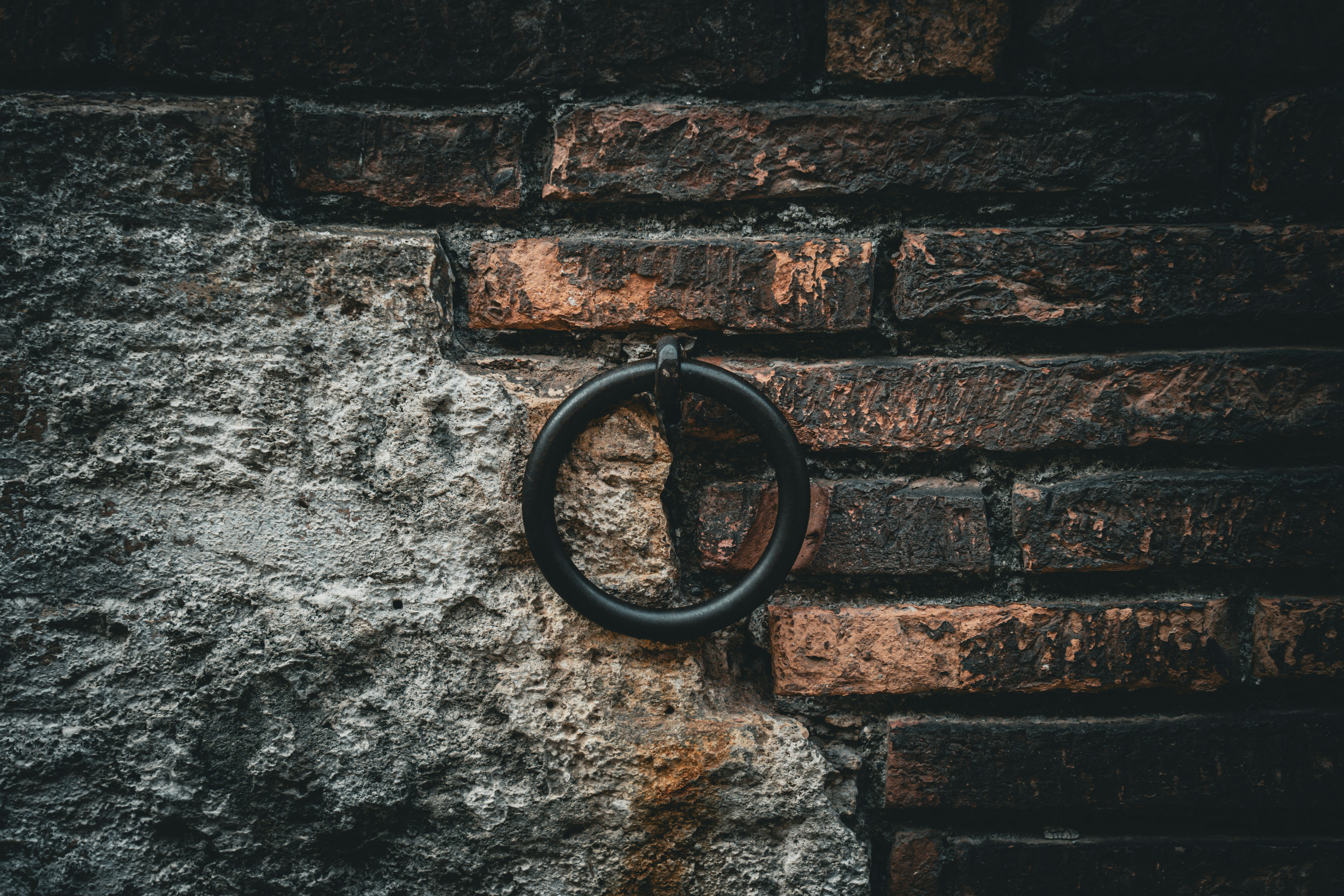 A metal ring on the side of a brick wall photo – Free Archaeological ...