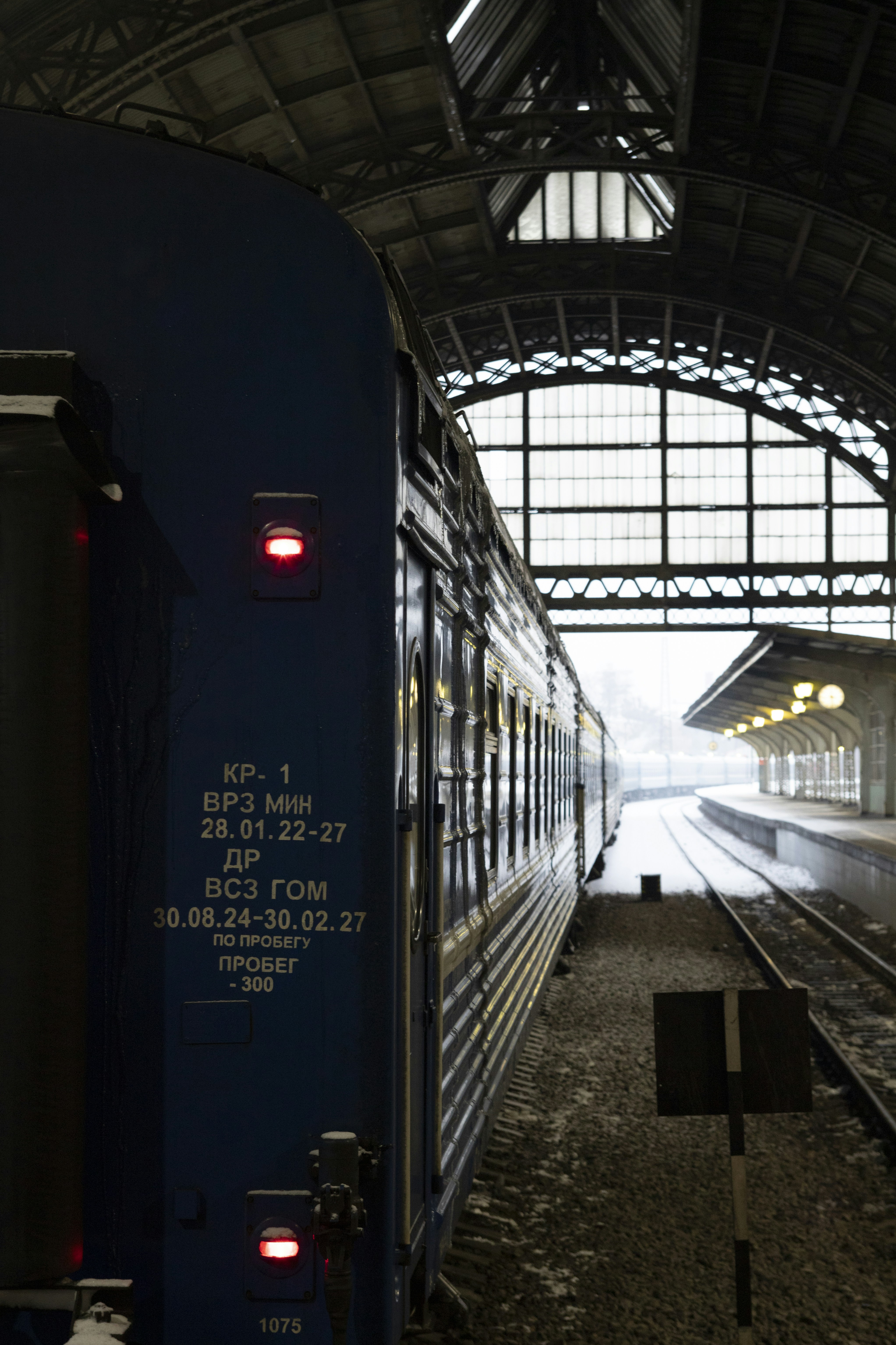 Blue Carriage Under Glass Arches: A Long View Along the Tracks