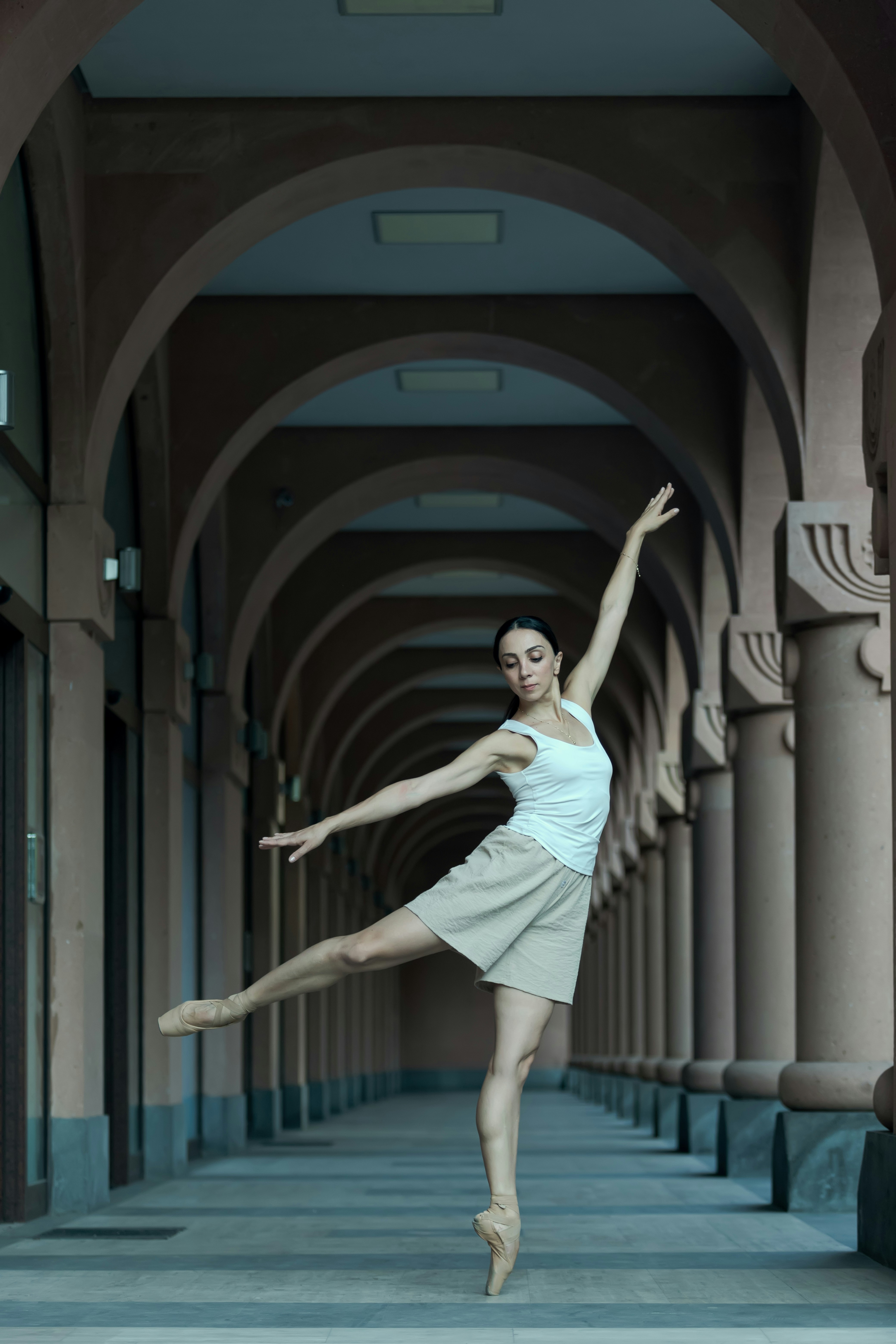 A woman in a white dress is dancing in a hallway photo – Free Yerevan ...