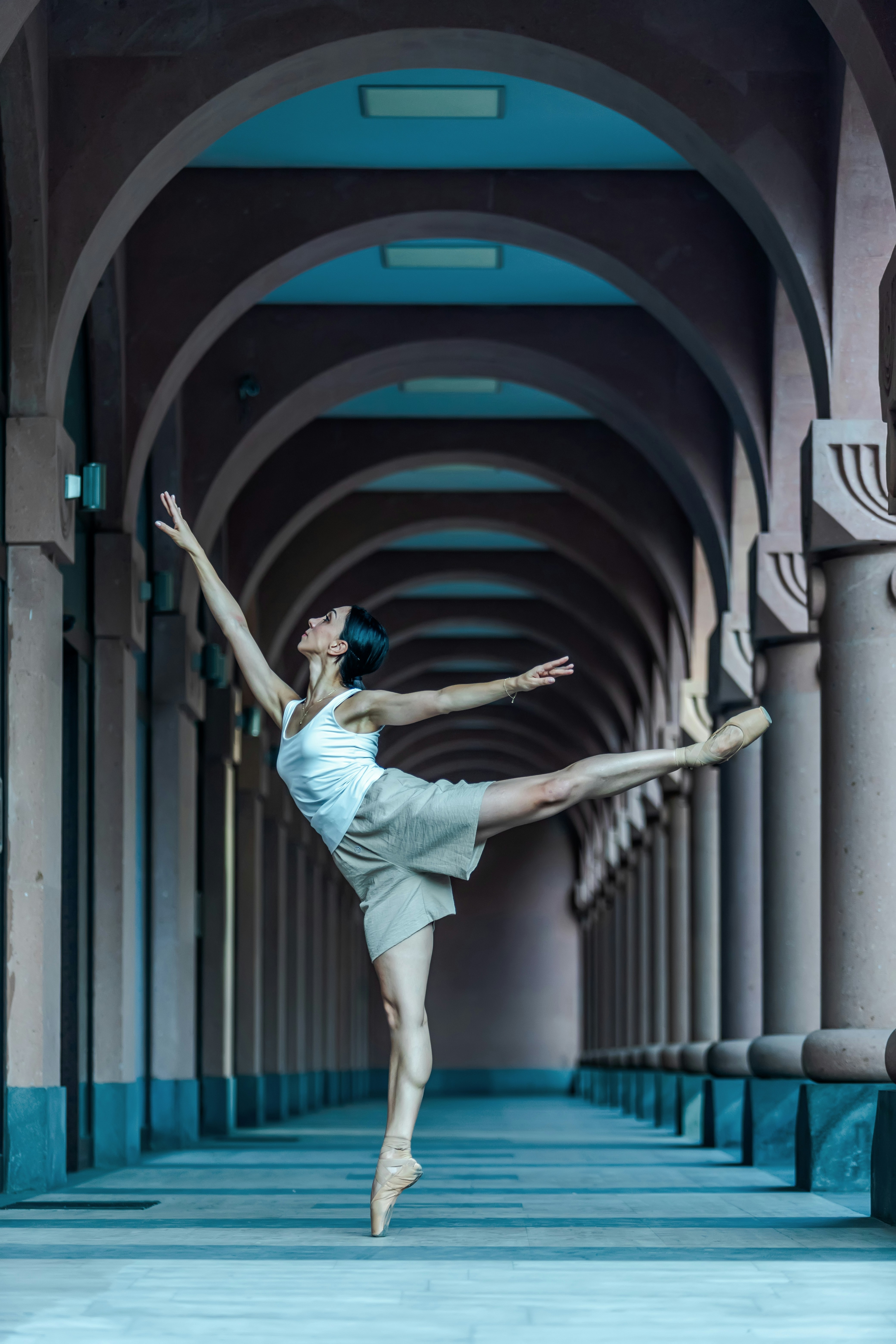 A ballerina in a white dress is doing a ballet move photo – Free ...