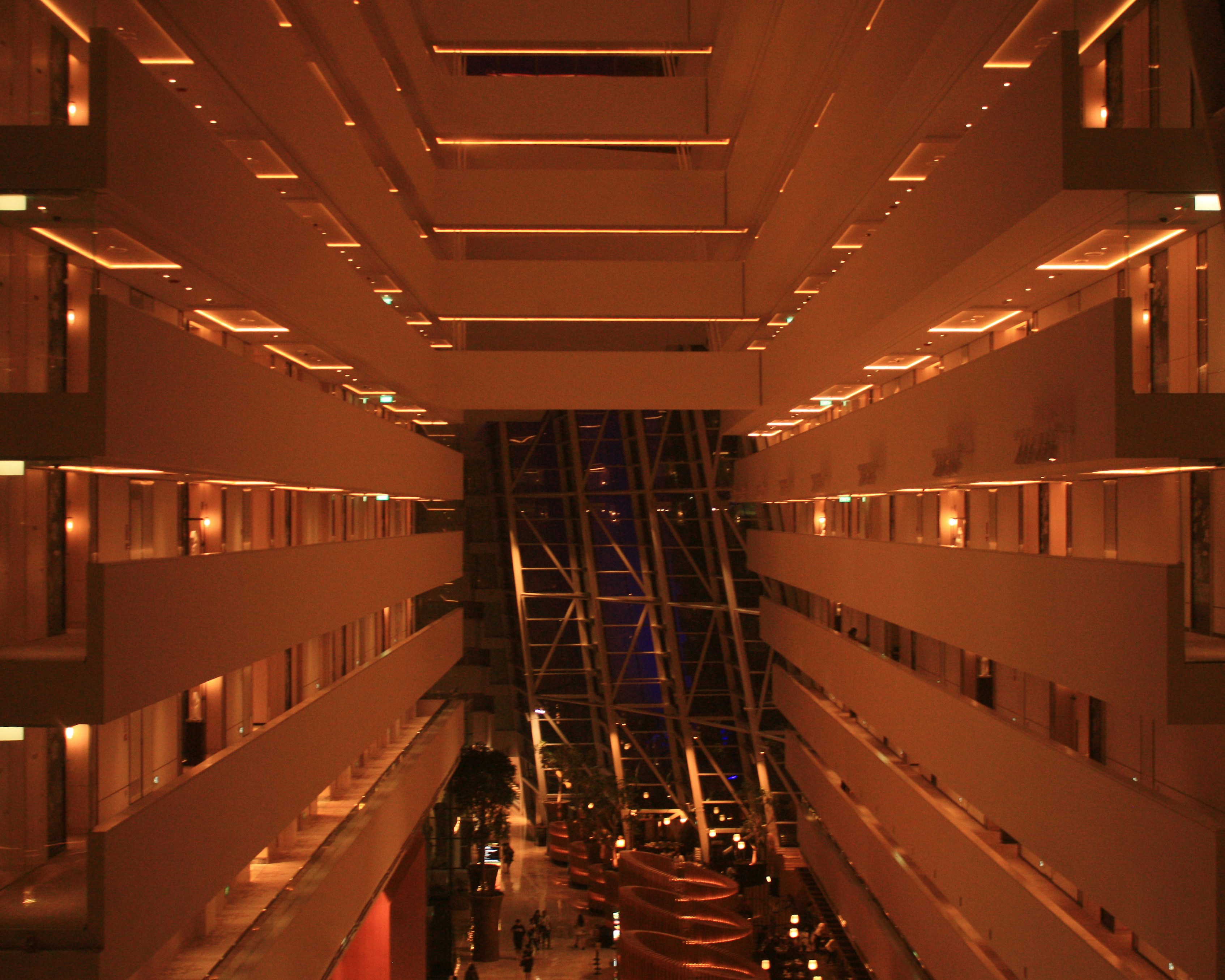 Amber Atrium: Vanishing Lines Converge on a Blue Glass Core
