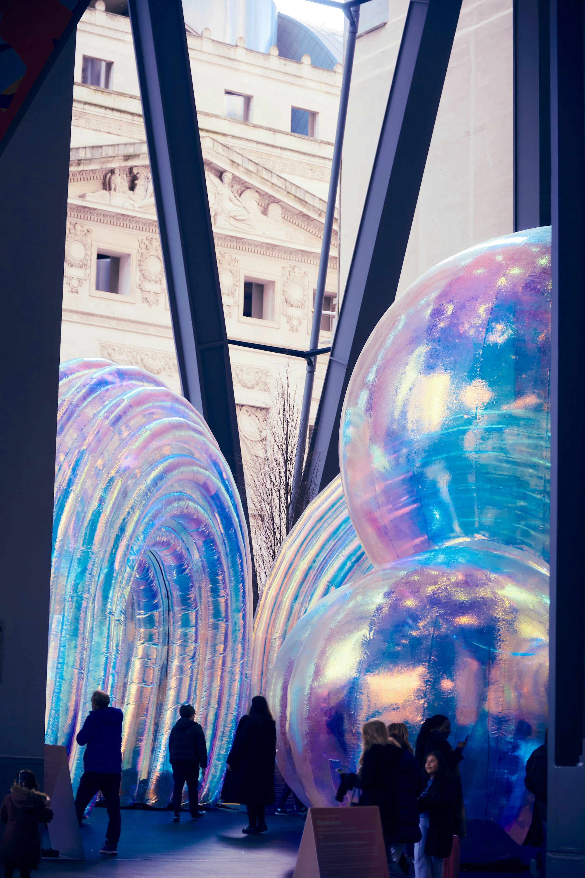 Iridescent Orbs in a Steel-Framed Atrium