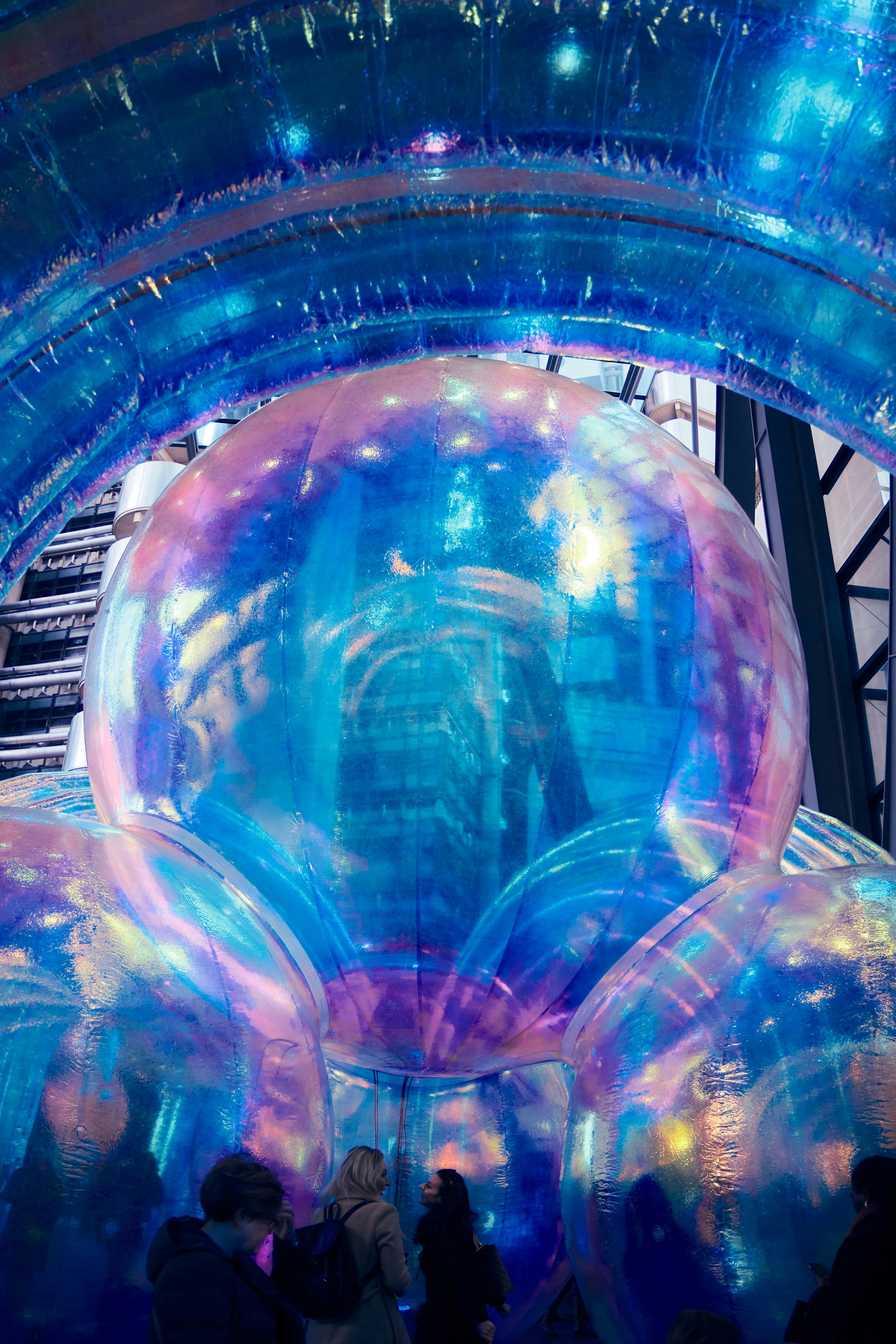 A group of people standing in front of a giant inflatable ball photo ...