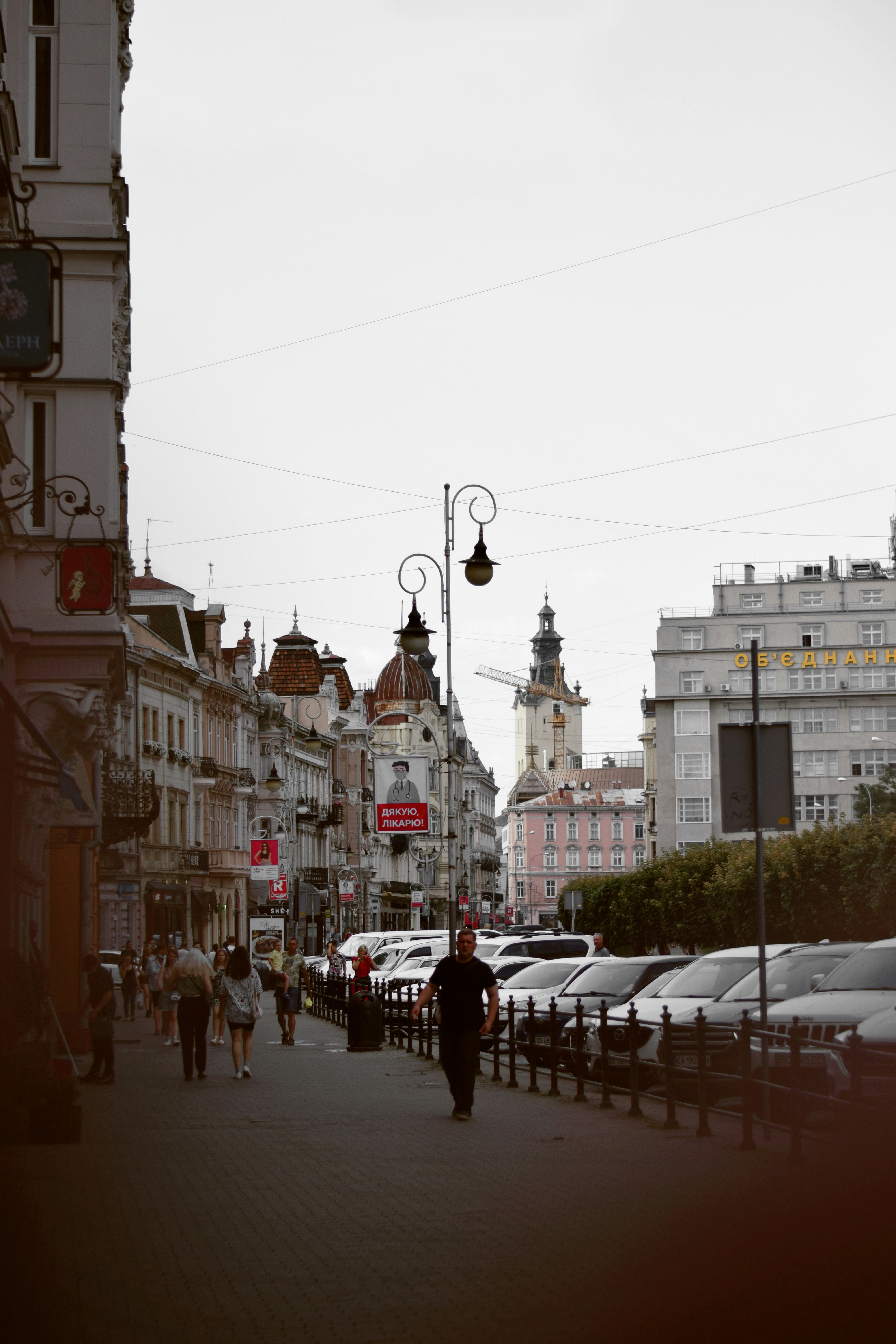 Center Street Pulse: A Lone Walker on a Historic European Boulevard
