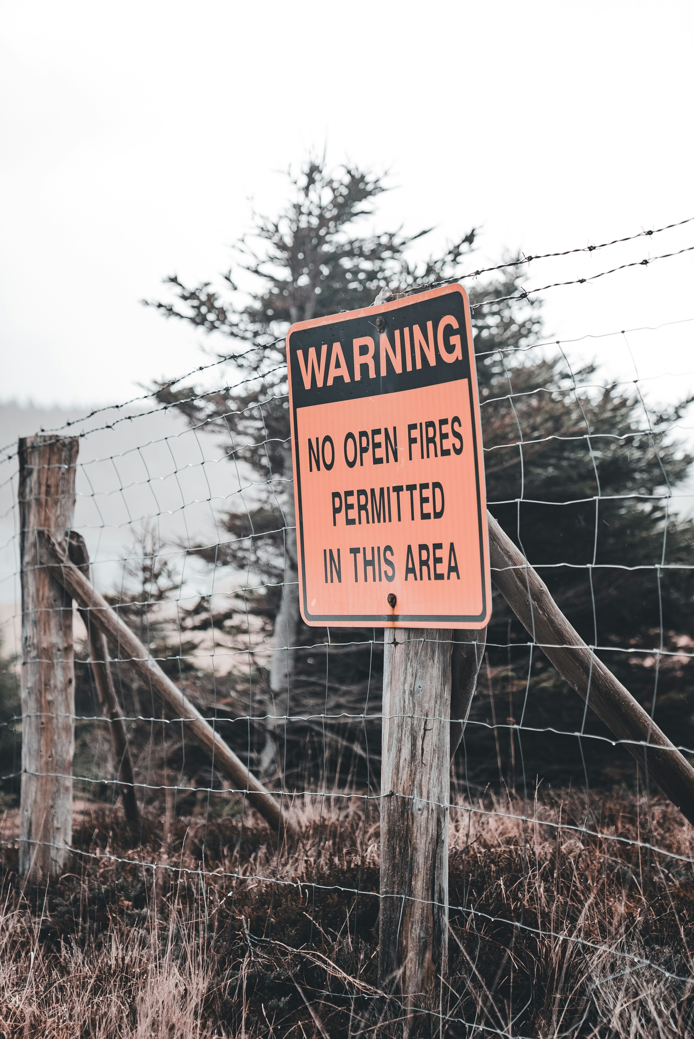 A warning sign posted on a barbed wire fence photo – Free Road sign ...