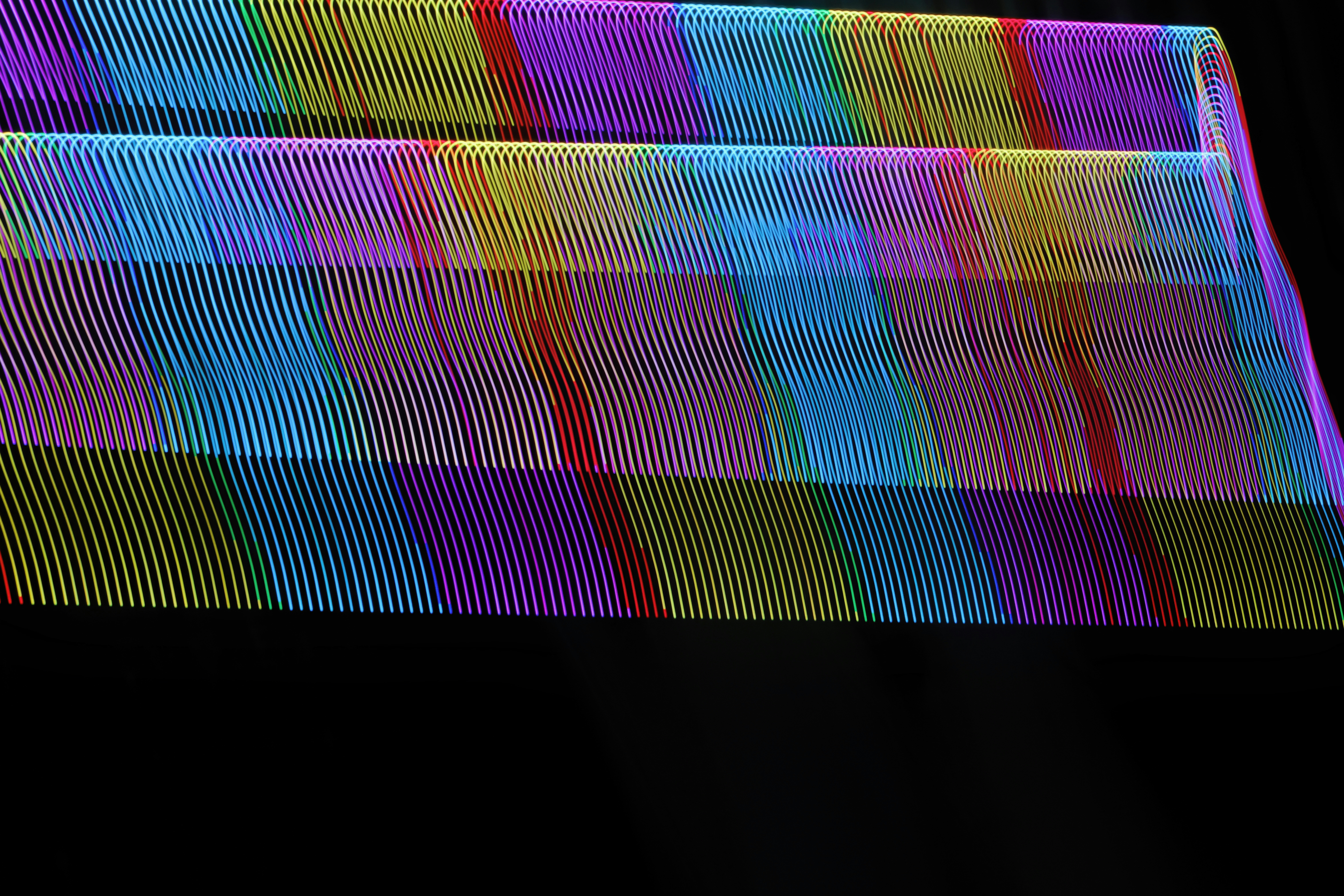 A close up of a multicolored object on a black background